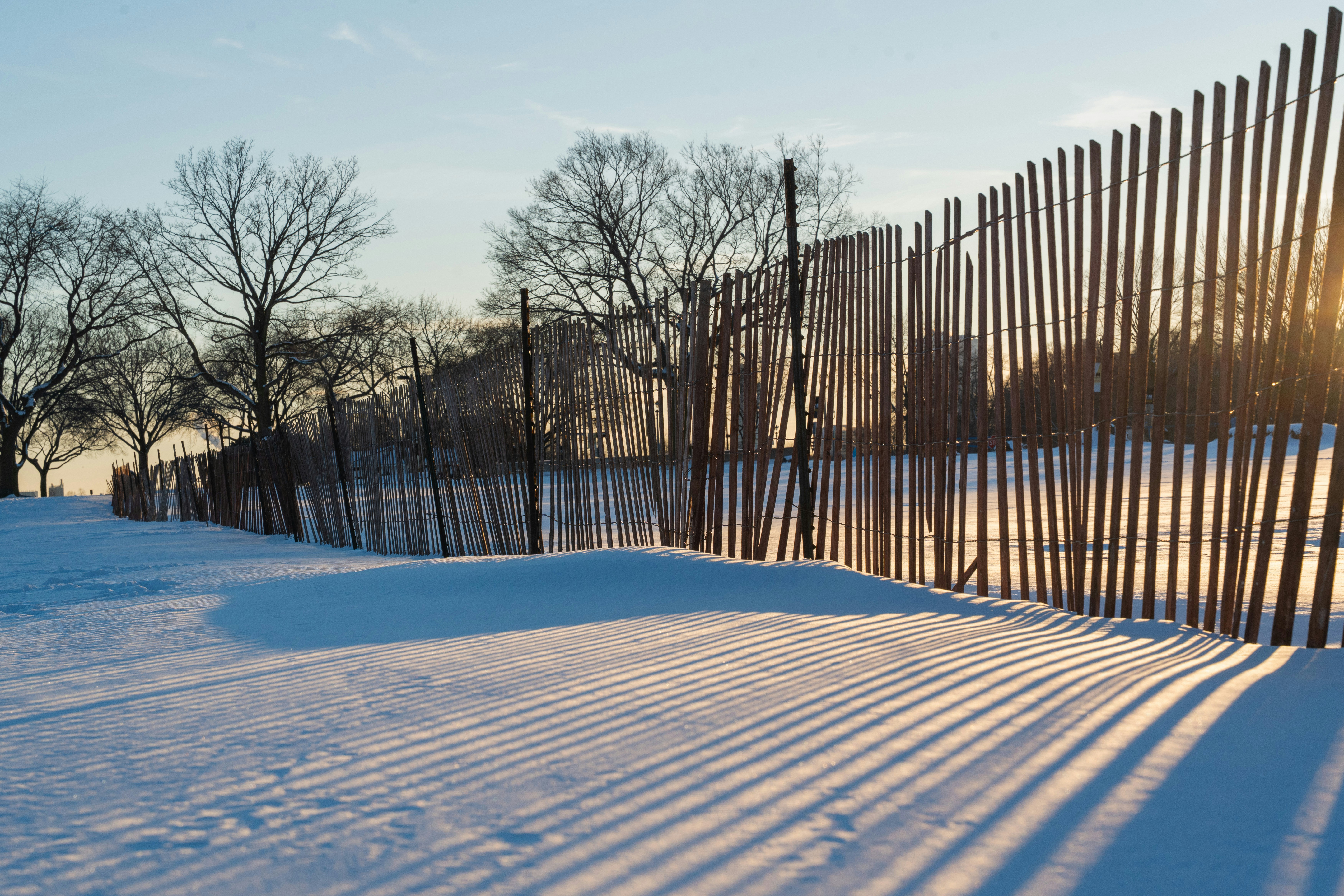 Snowy landscape with a wooden fence and long shadows. photo – Free ...