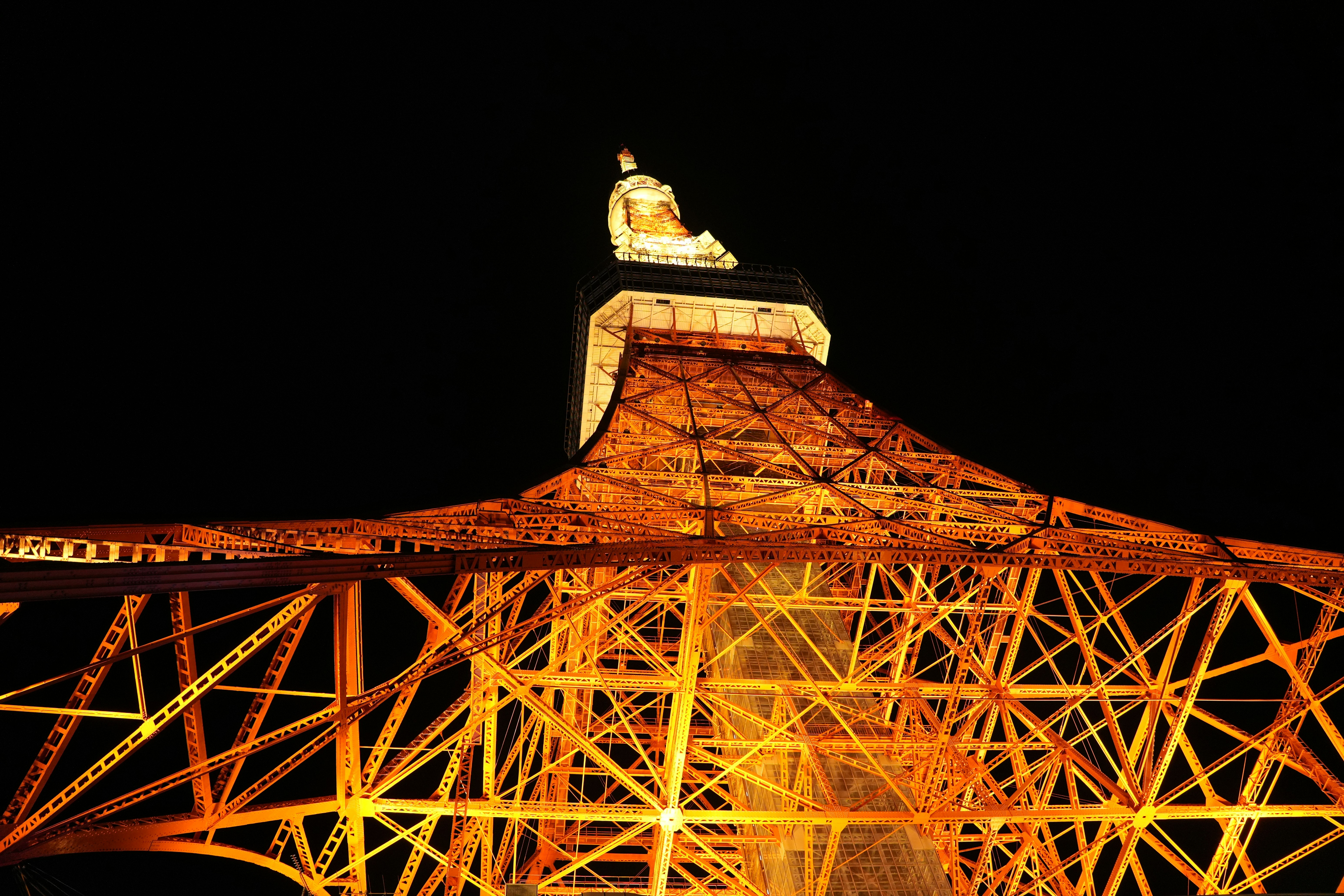 A close-up, night view of the illuminated Tokyo Tower.