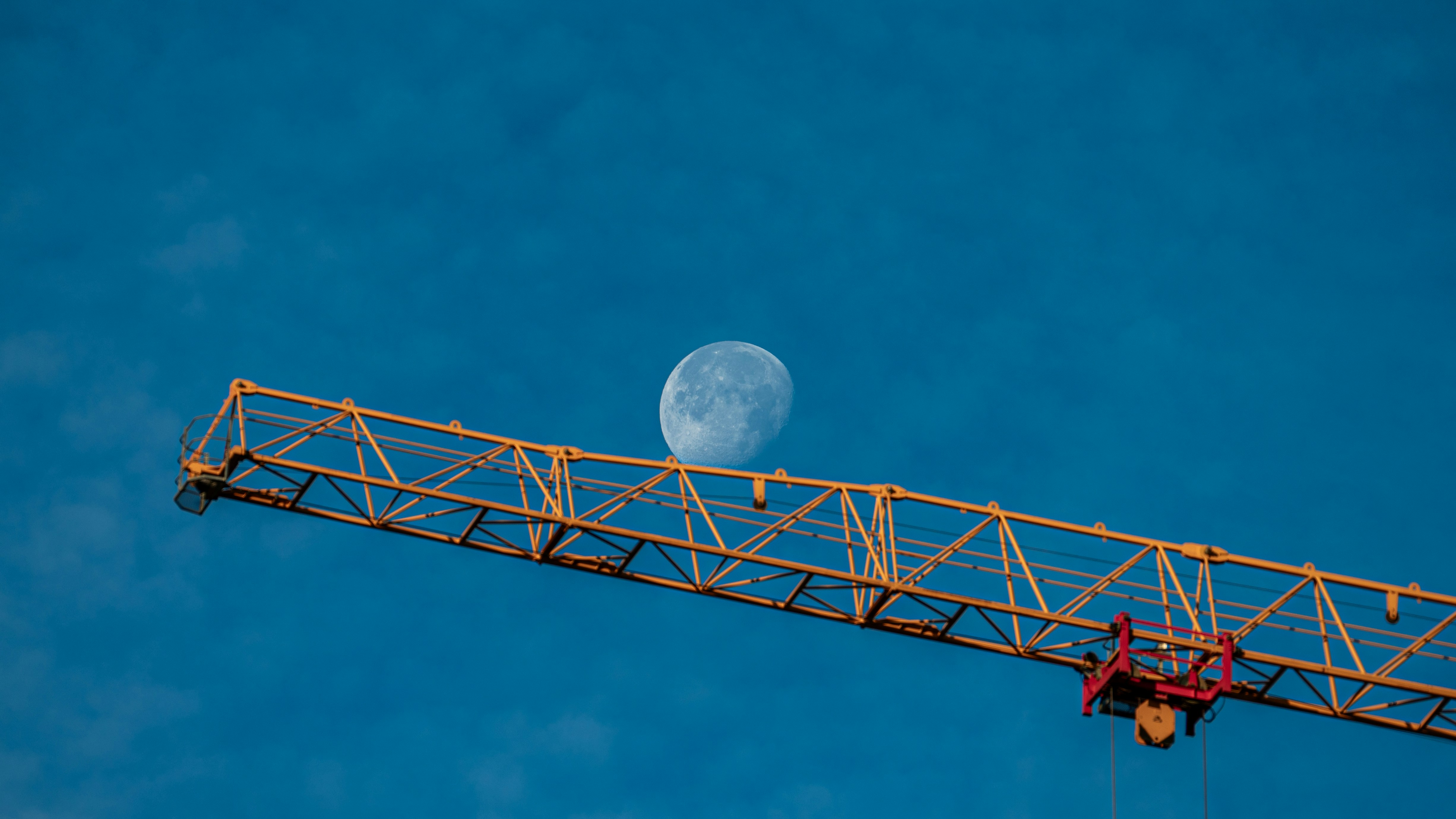 The moon crosses the tower crane