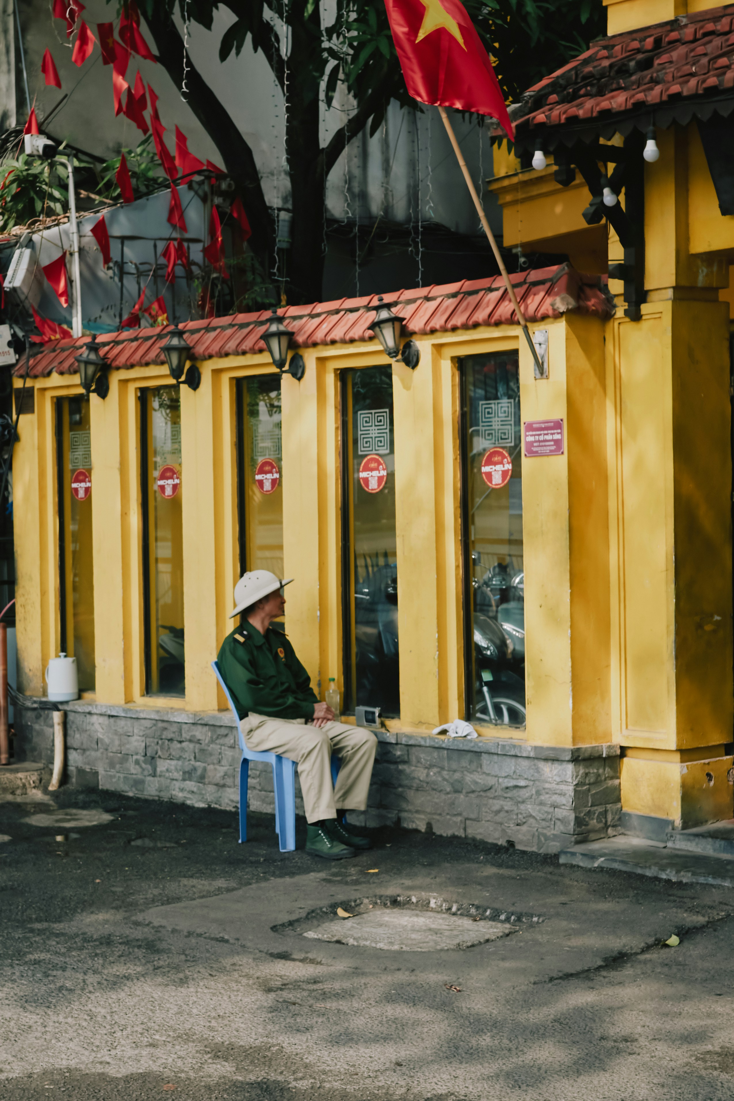 Quiet Vigil at a Sunlit Yellow Arcade