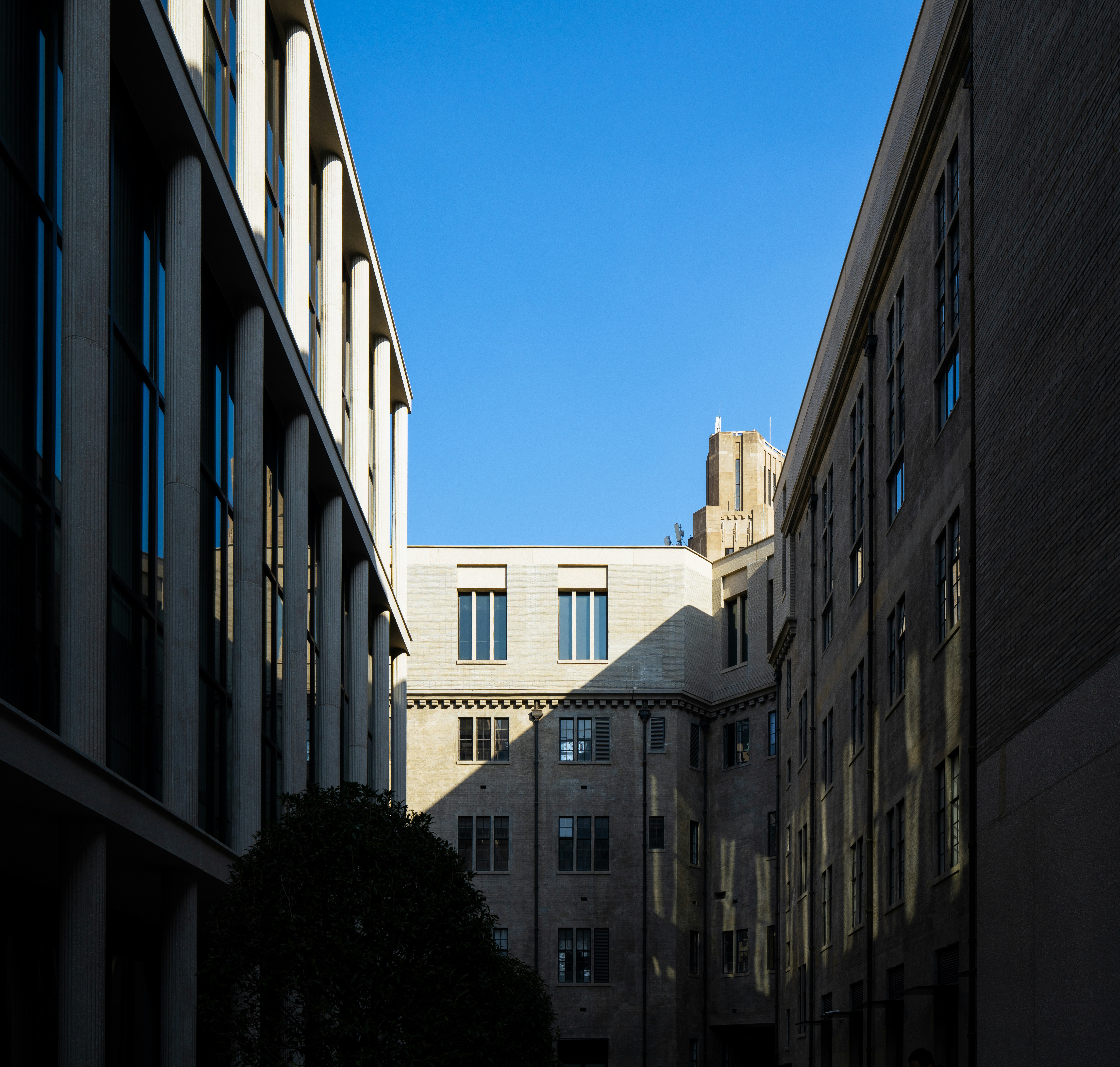 Buildings with geometric shadows under clear blue sky photo – Free ...