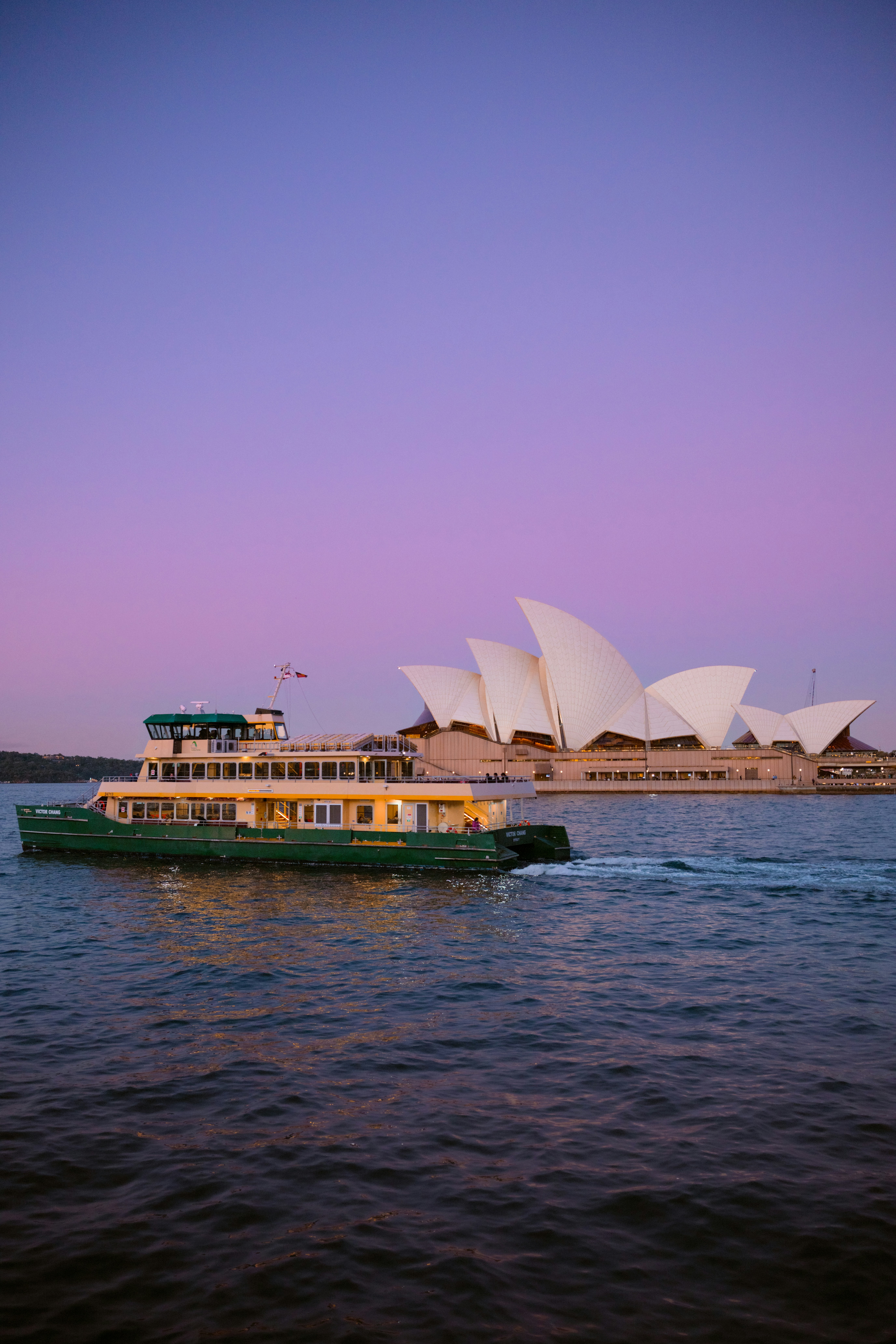 Crescent Skies over the Opera: A Ferry in Sunset Bay