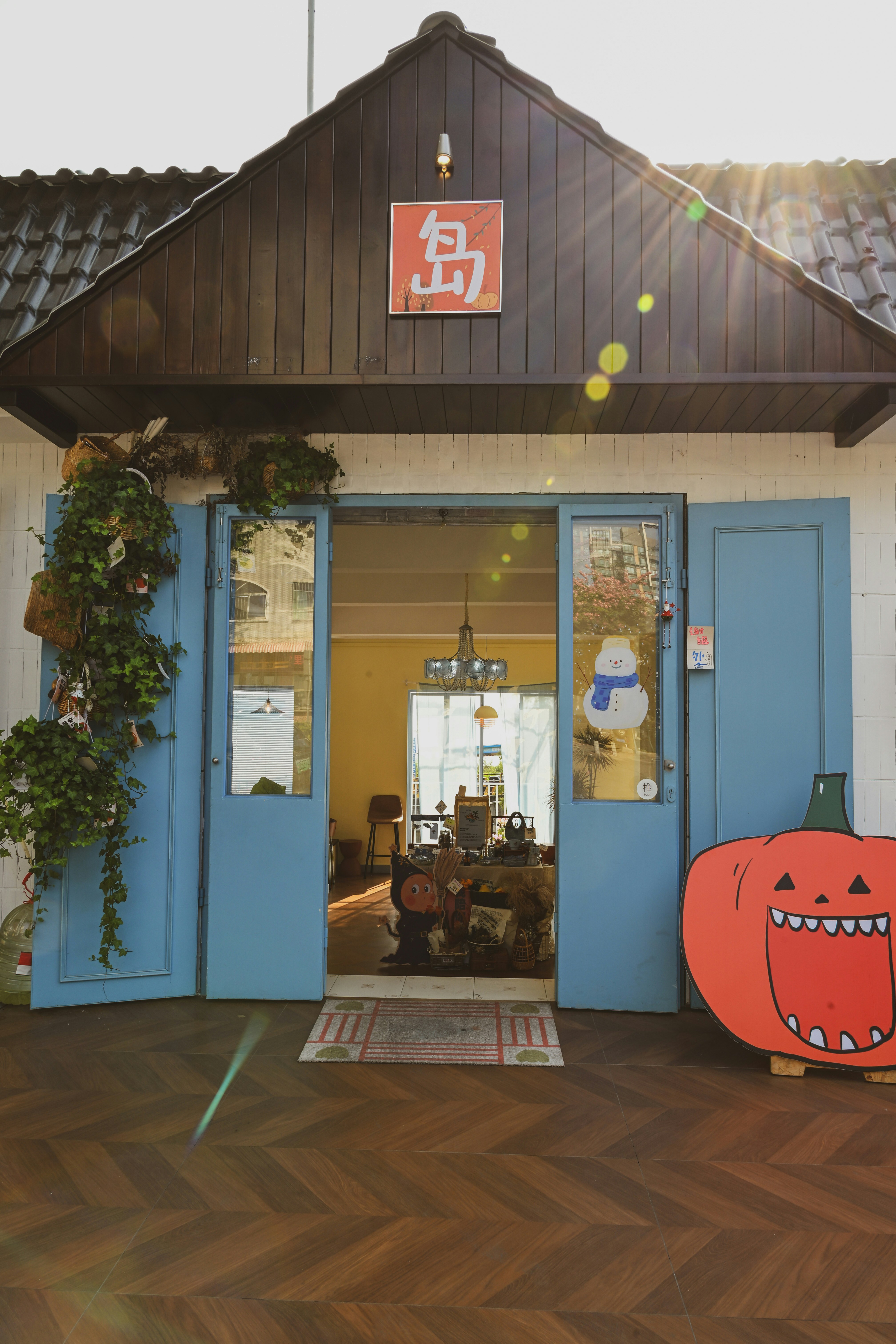 Blue Doors Open to a Cozy Interior with a Pumpkin Prop