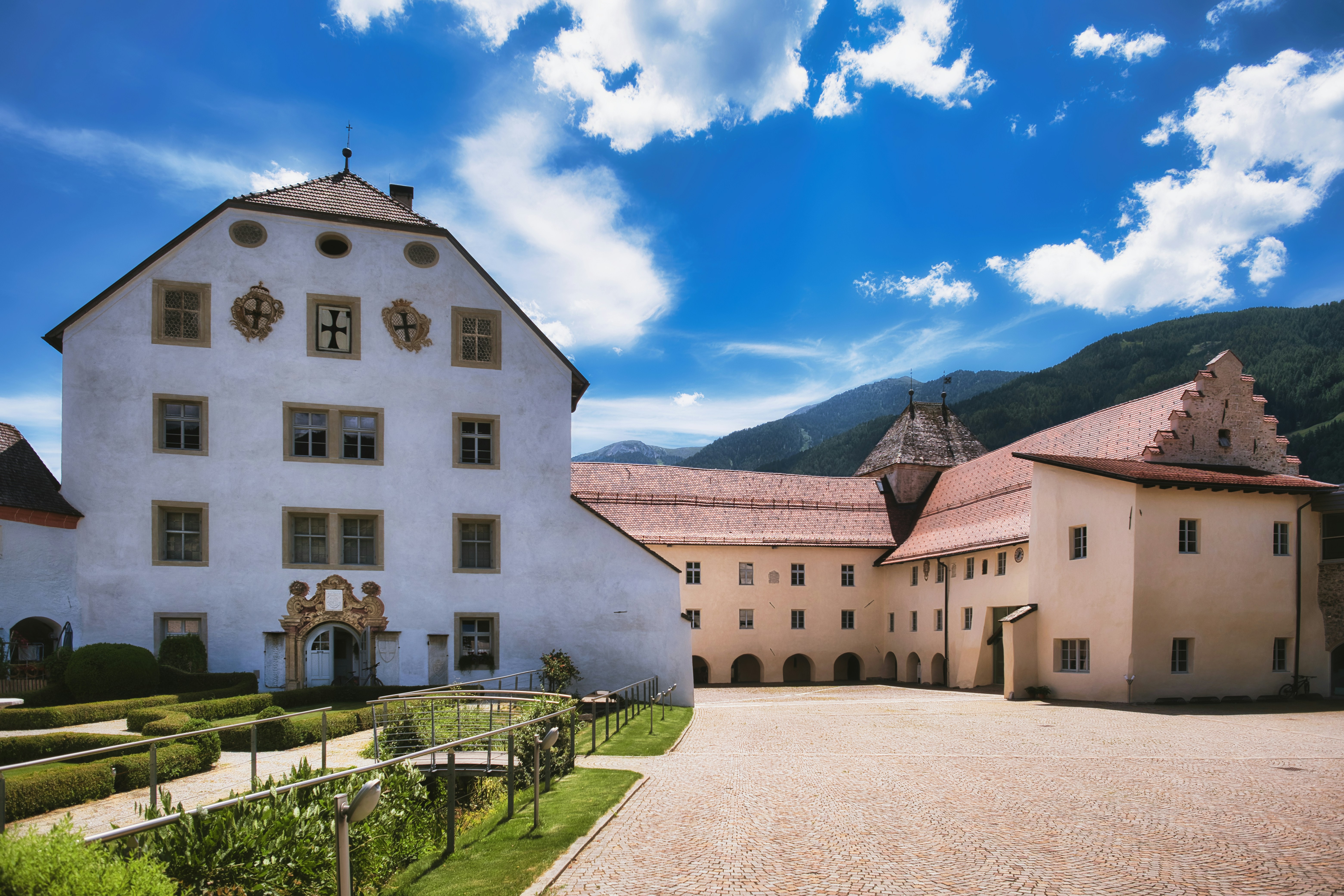 Courtyard of the Alpine Manor: A Sunlit Pastiche of Windows and Rooflines