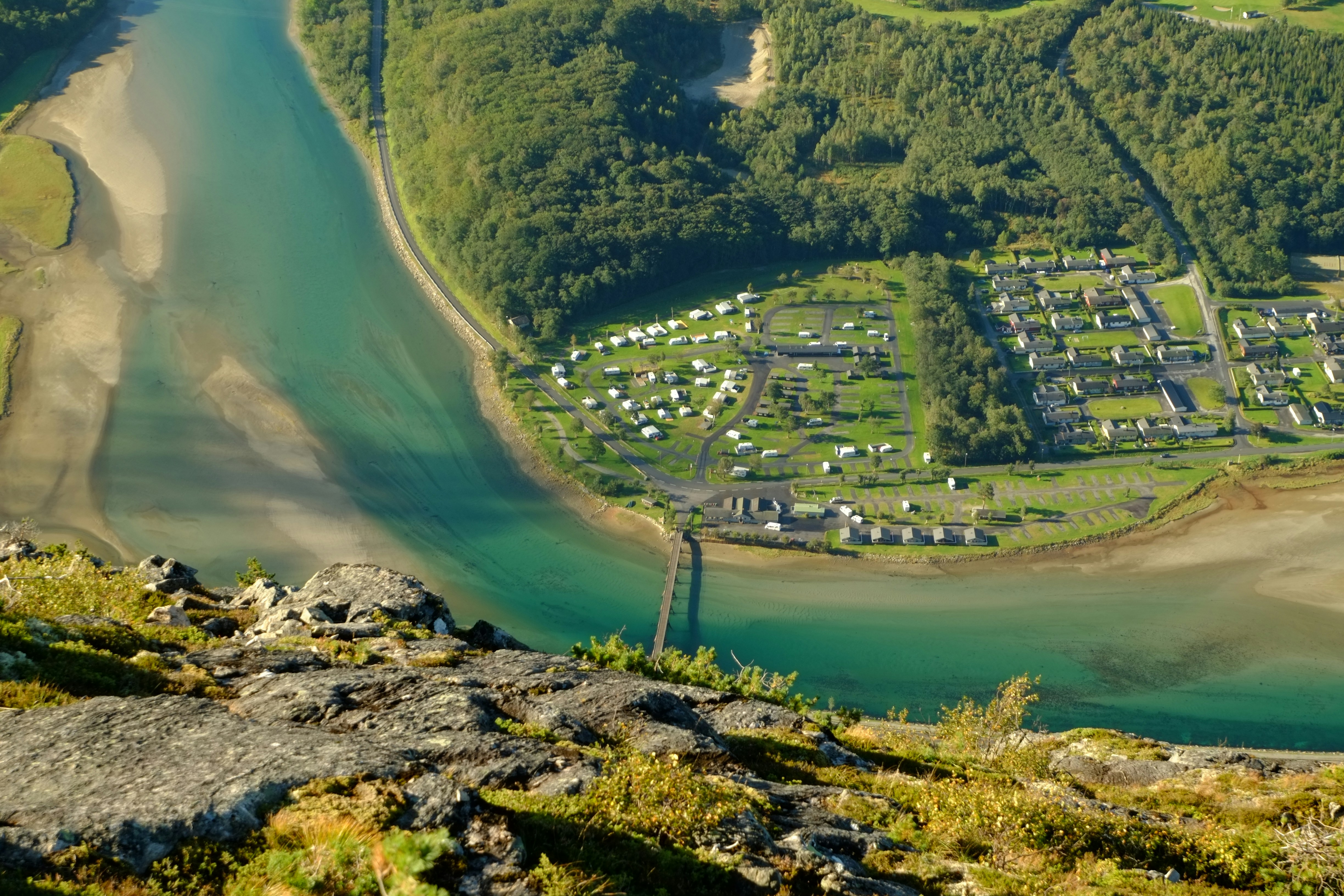 Aerial View into a Trimmed Tide: Cliffside Path to Coastal Campground