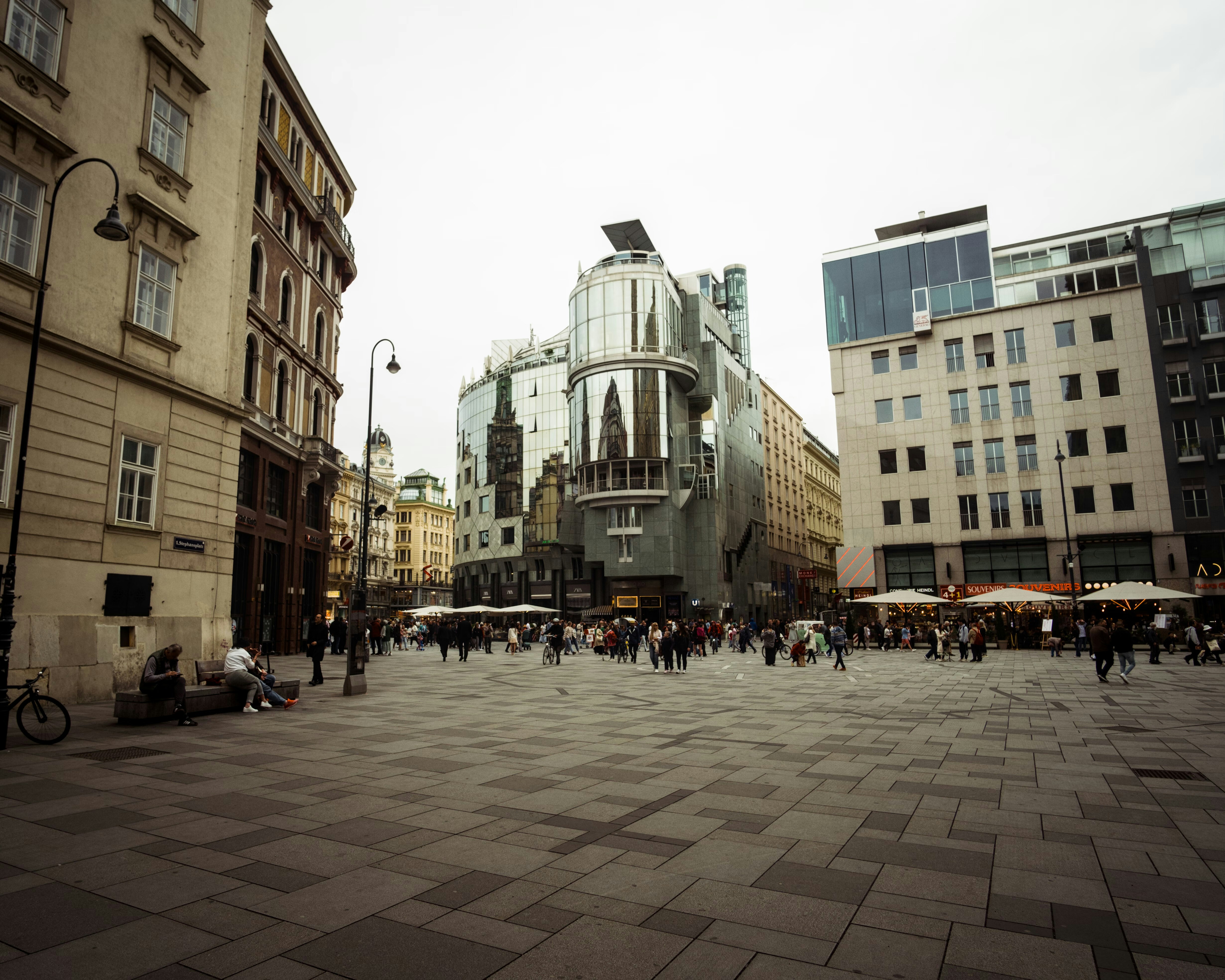 Angular City Pulse Beneath a Curved Glass Facade