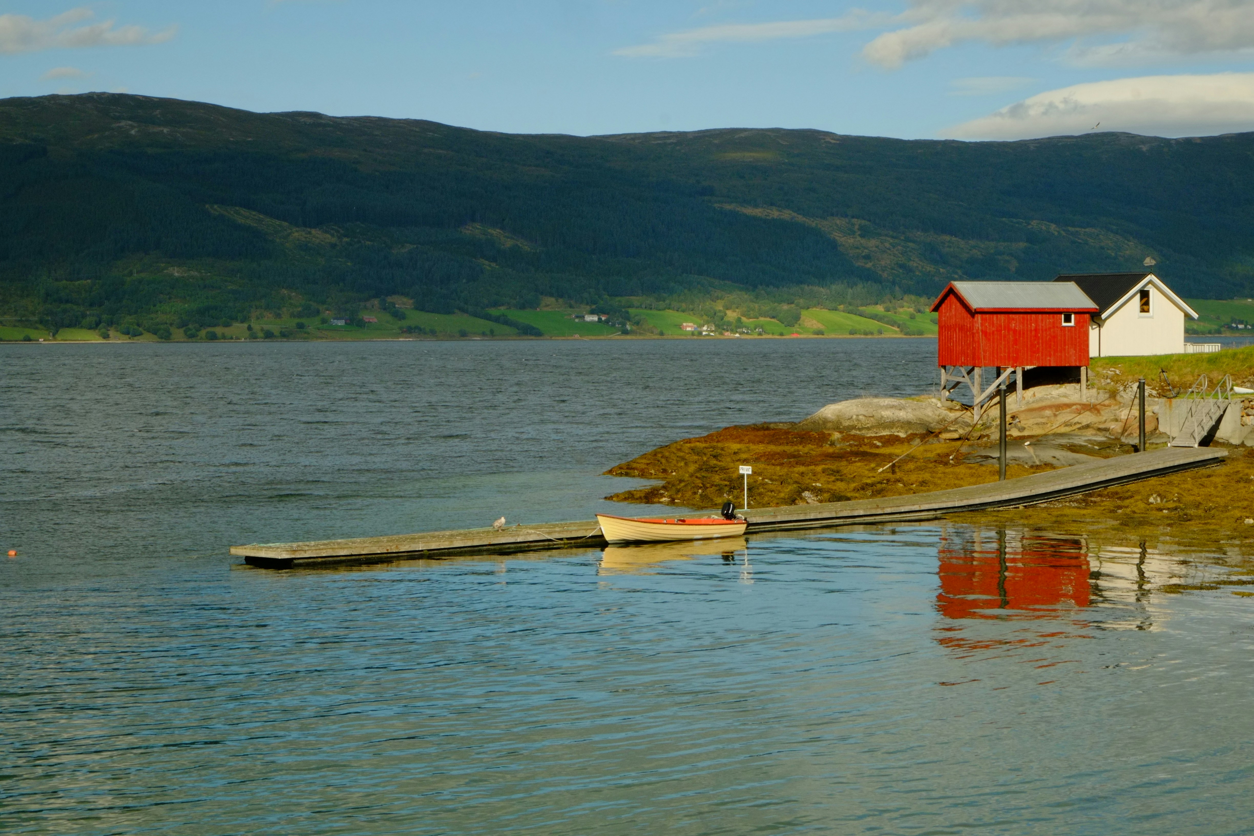 Red Boathouse by the Quiet Fjord