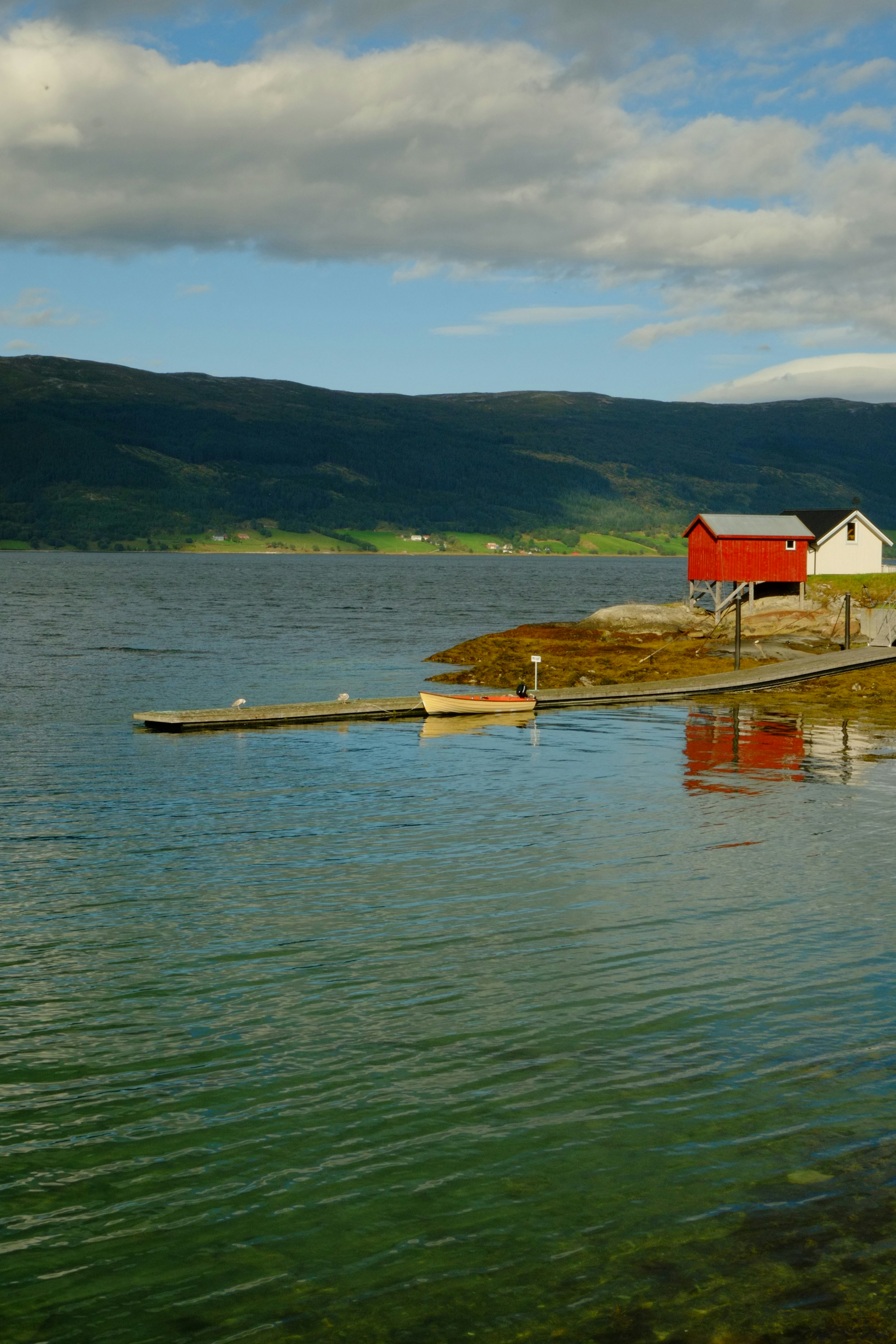 Red Boathouse on a Quiet Fjord
