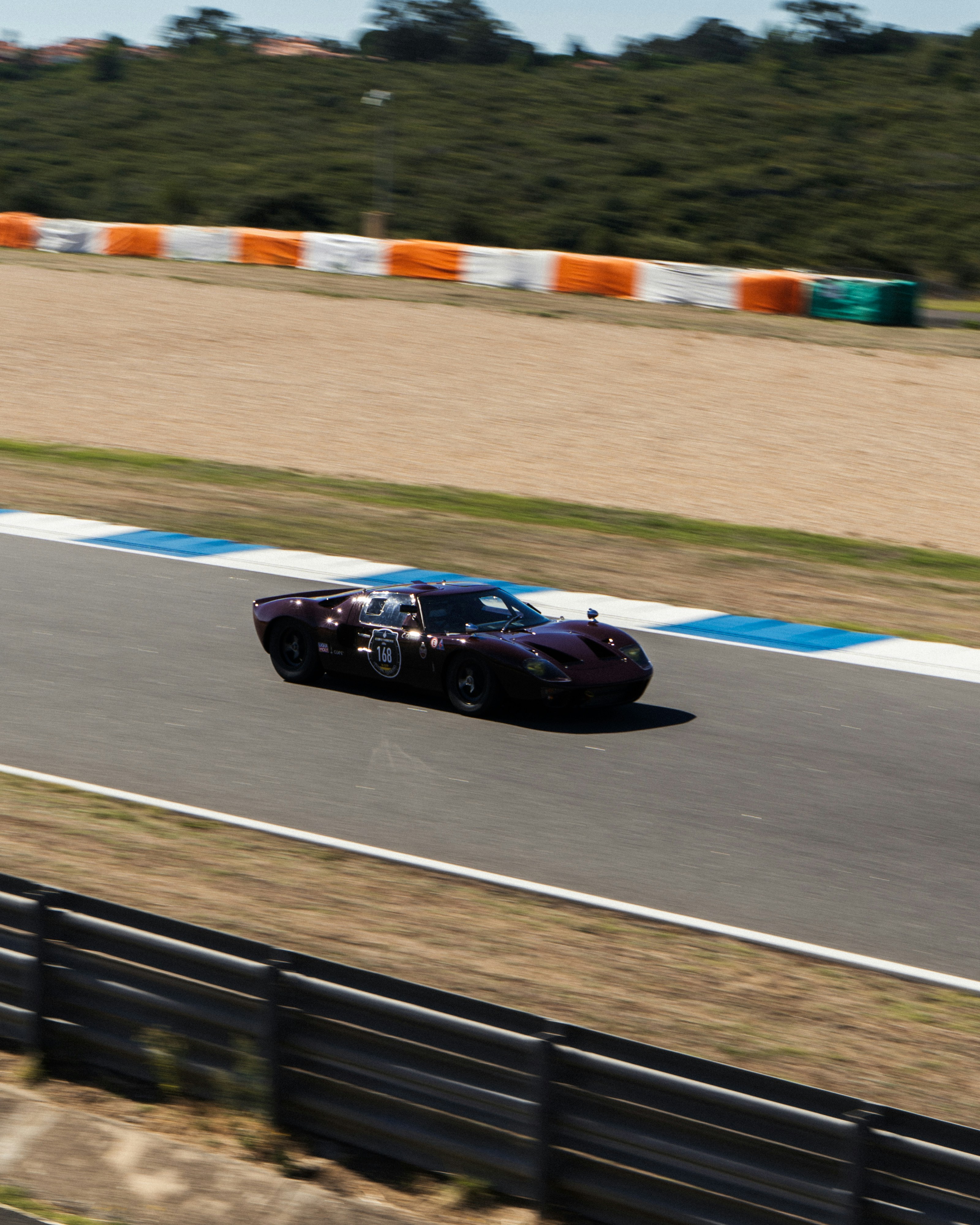 Maroon Vintage Racer in Motion on a Track