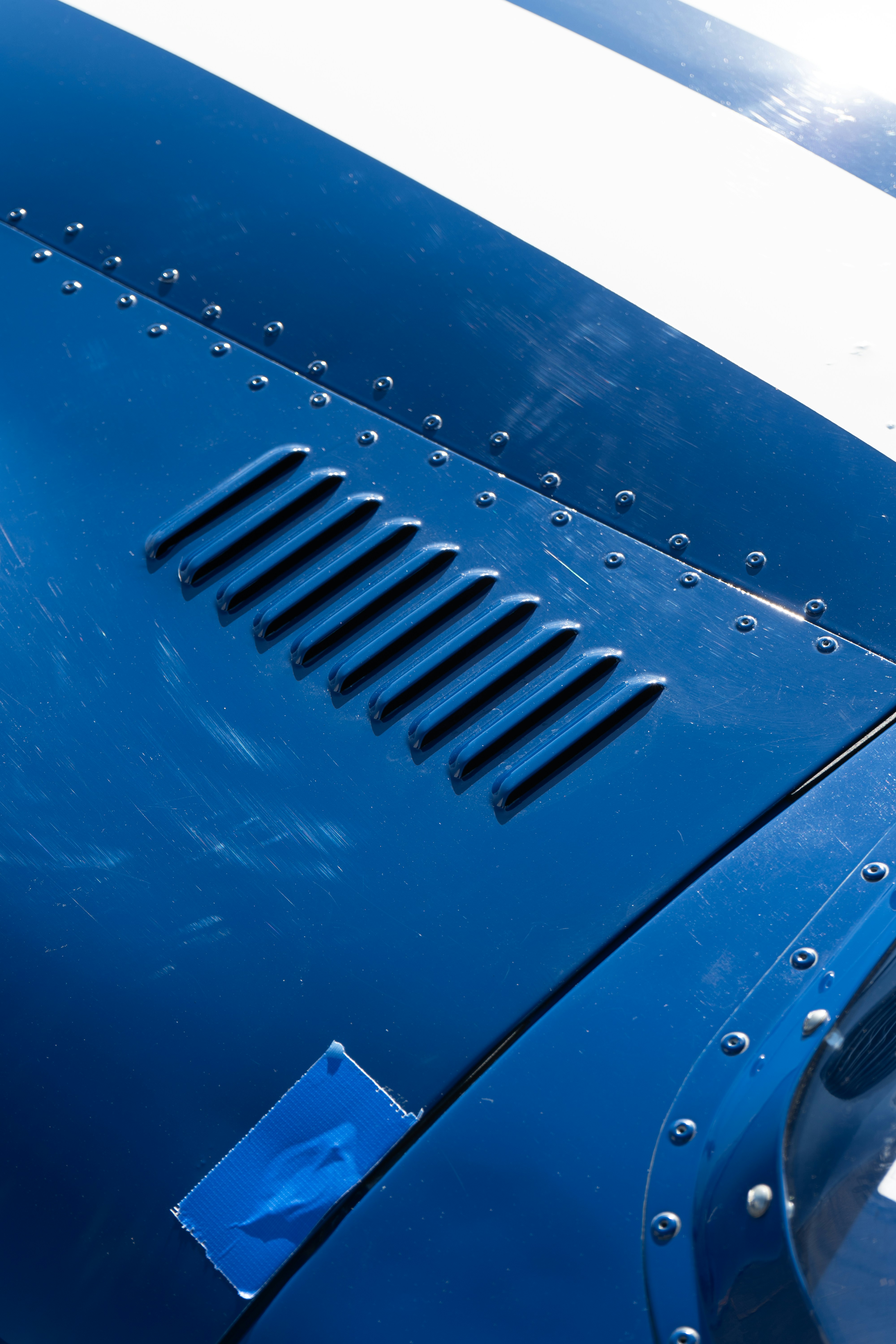 Blue Velocity: Strained Strips and Vented Lines on a Runway Surface