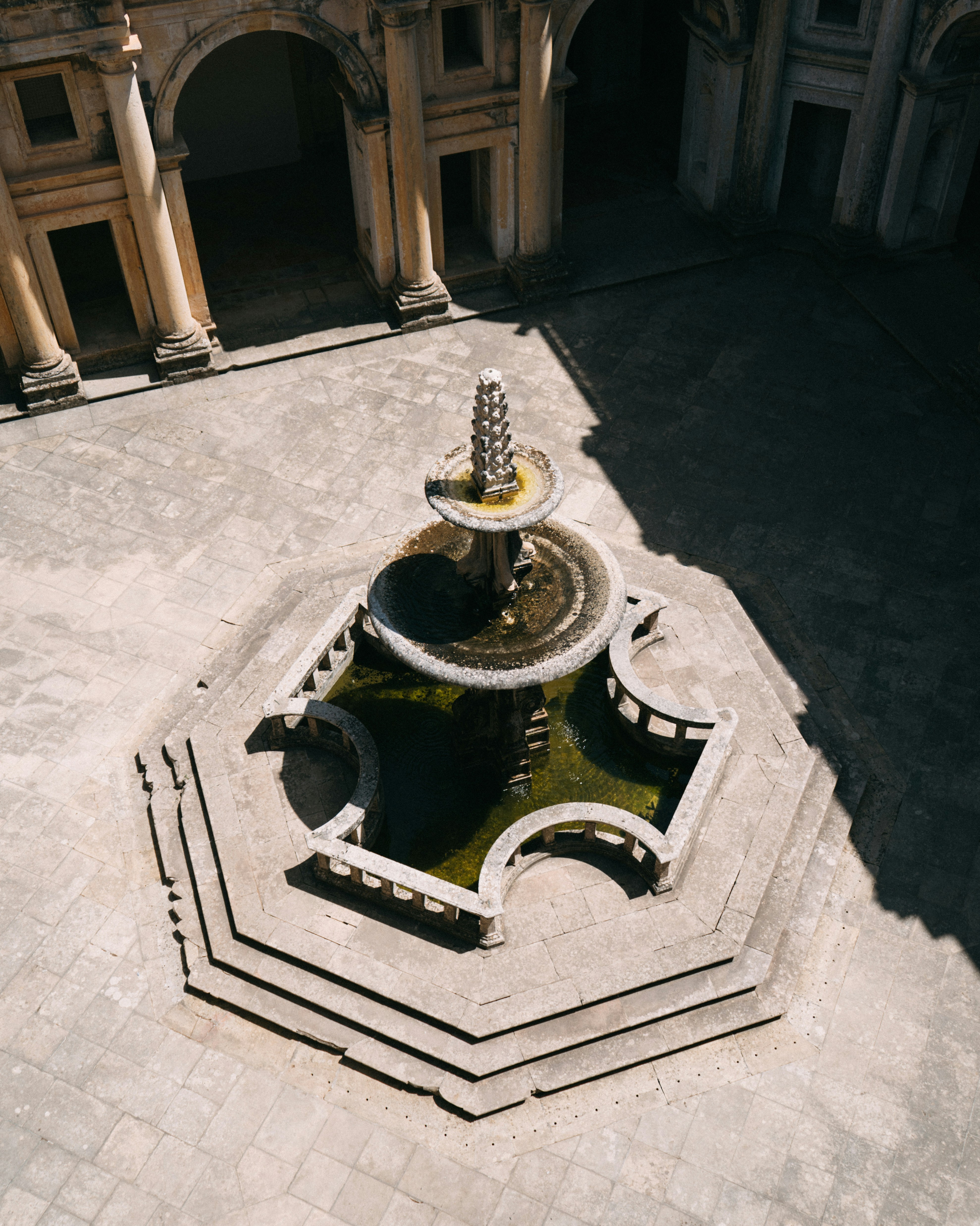 Central Courtyard Fountain: Geometric Steps Lead to Heritage Shadows