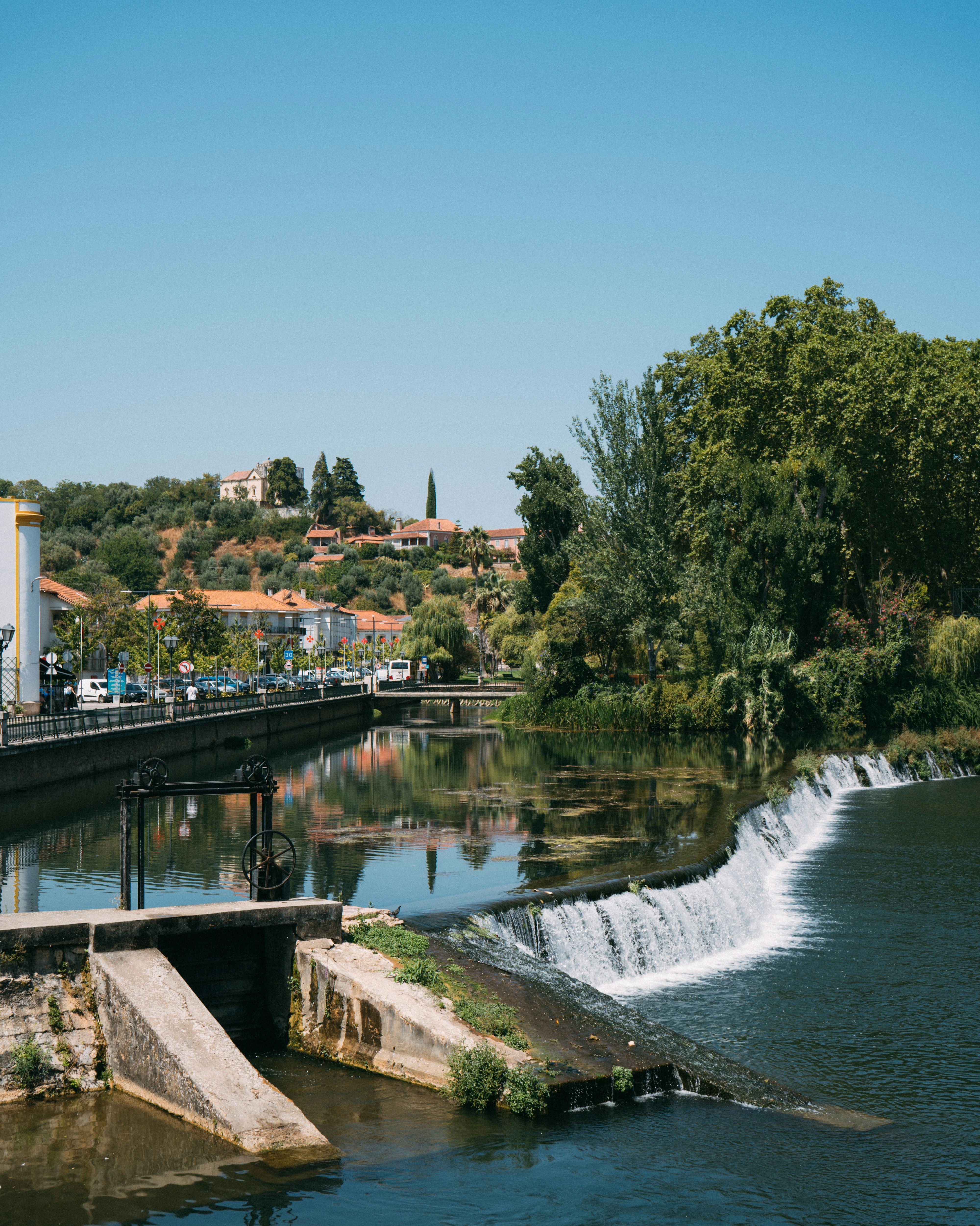Riverside Quay: A Quiet Town Framed by Water, Trees, and Red-Tiled Roofs