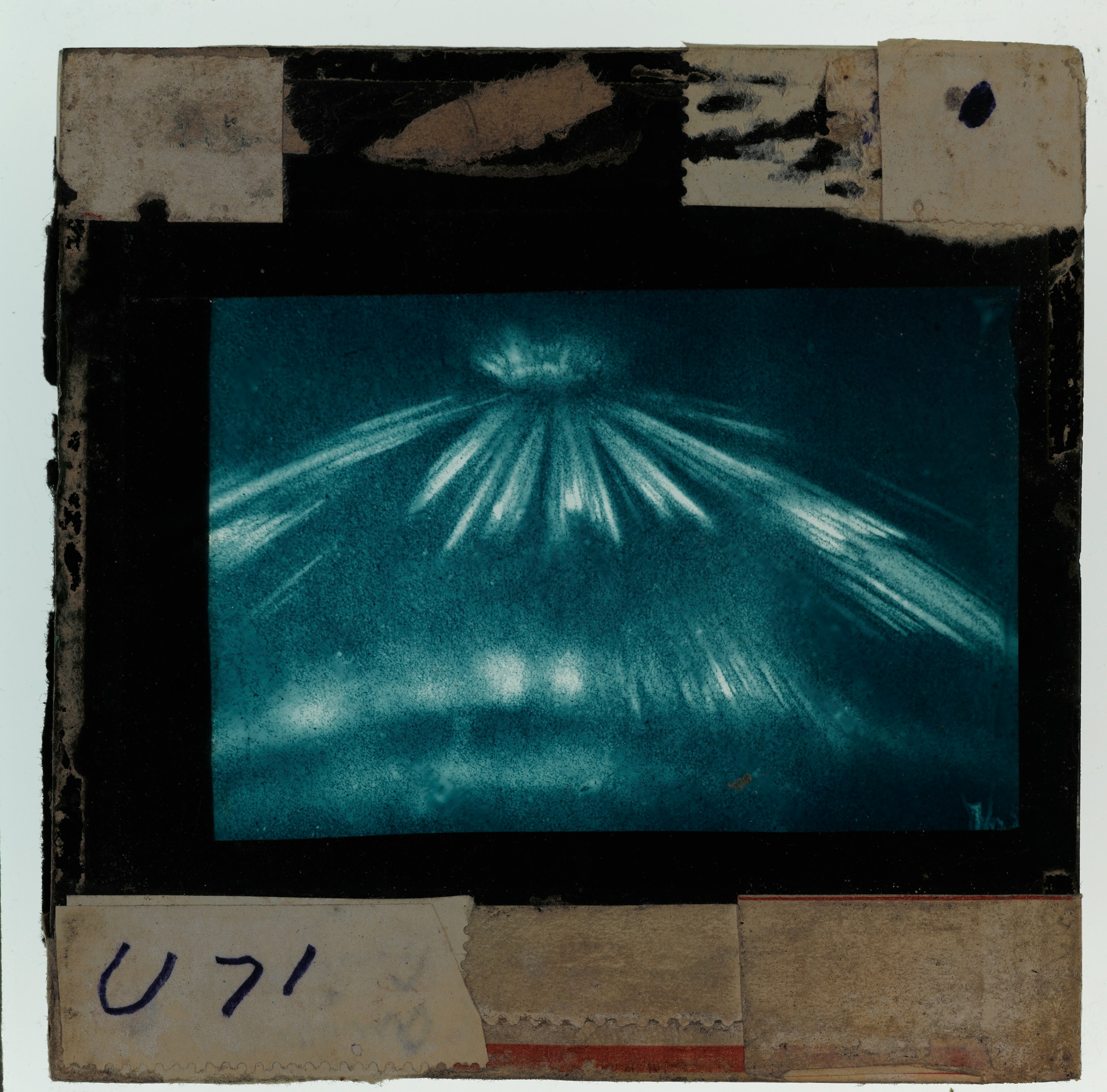 "A lantern slide produced by Clement Lindley Wragge (b.1852, d.1922), likely dating between 1890-1922. The slide shows blue tinted image depicting rays of light radiating down from a small, oval shaped light source in the top centre of the plate. Shared by Auckland War Memorial Museum, Tāmaki Paenga Hira, as part of the Clement Lindley Wragge collection. 236029|PH-1984-1-LS78-4-22|71. No known copyright restrictions. https://www.aucklandmuseum.com/discover/collections/record/1033187"