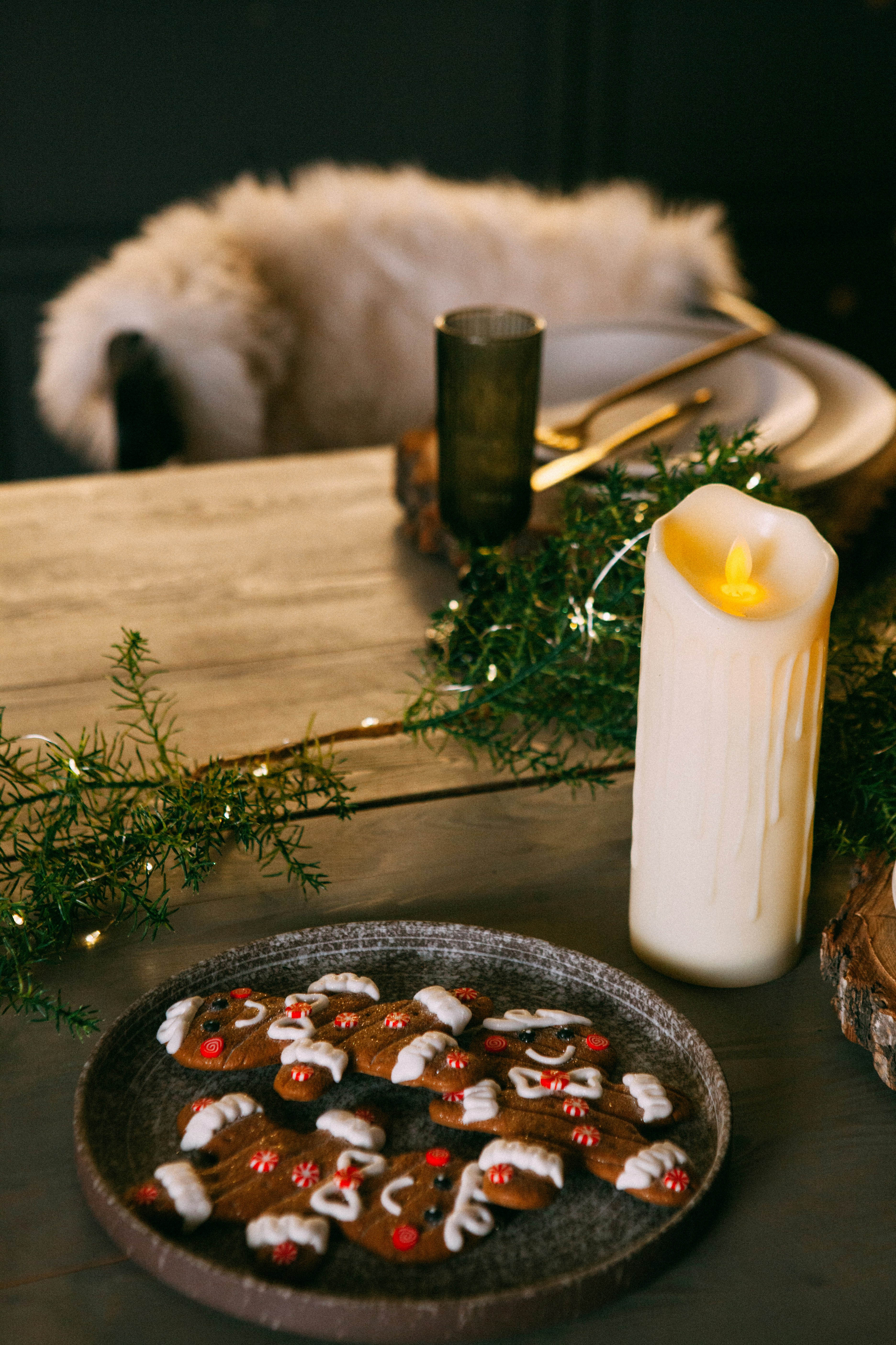 Candlelit Holiday Tray with Gingerbread Cookies on a Rustic Table