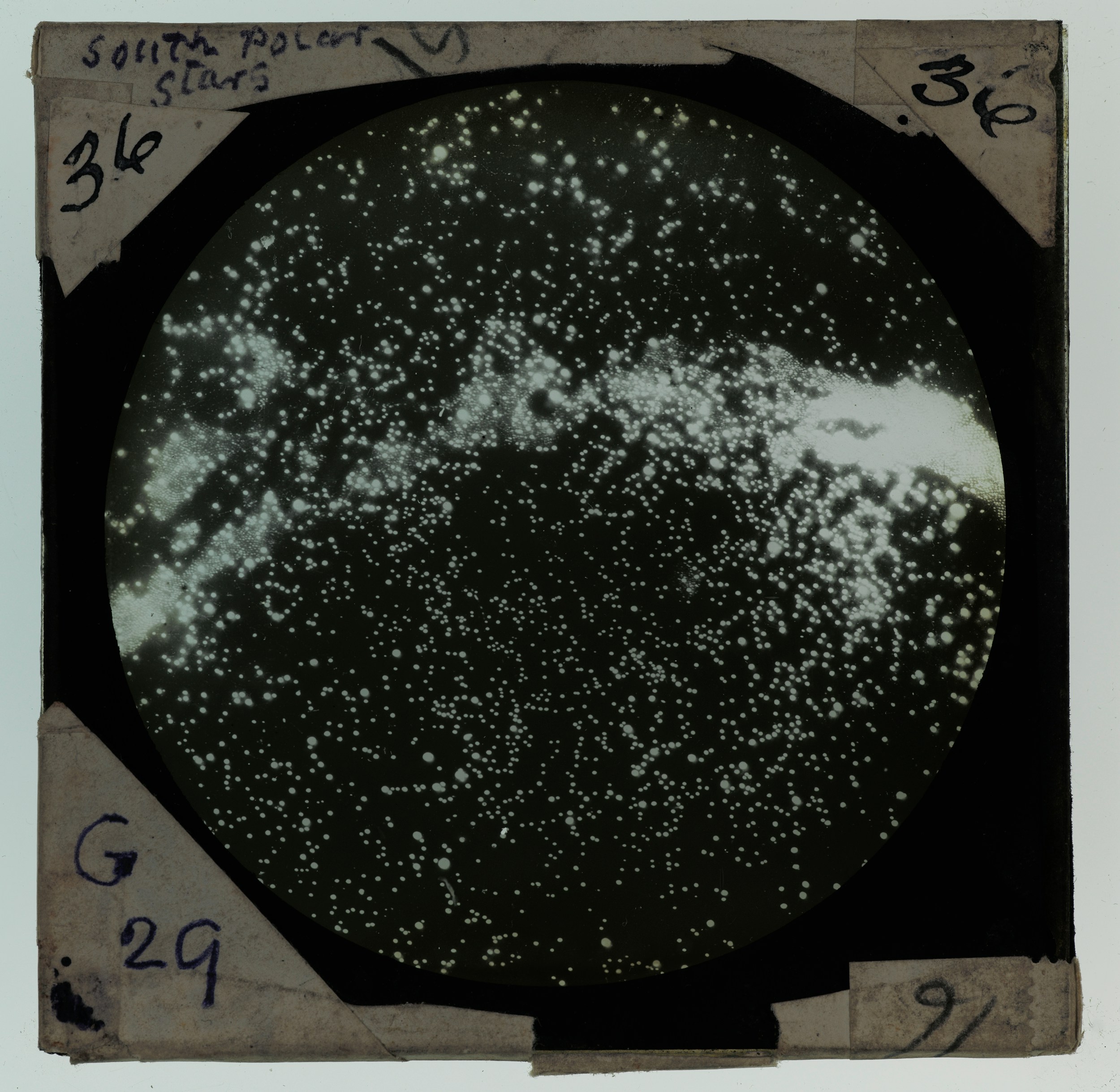 A lantern slide produced by Clement Lindley Wragge (b.1852, d.1922), date unknown. The slide shows an image of curved cluster of stars (possibly the Milky Way). Shared by Auckland War Memorial Museum, Tāmaki Paenga Hira, as part of the Clement Lindley Wragge collection. 235946|PH-1984-1-LS78-3-17|29|36|16. No known copyright restrictions. https://www.aucklandmuseum.com/discover/collections/record/1033269
