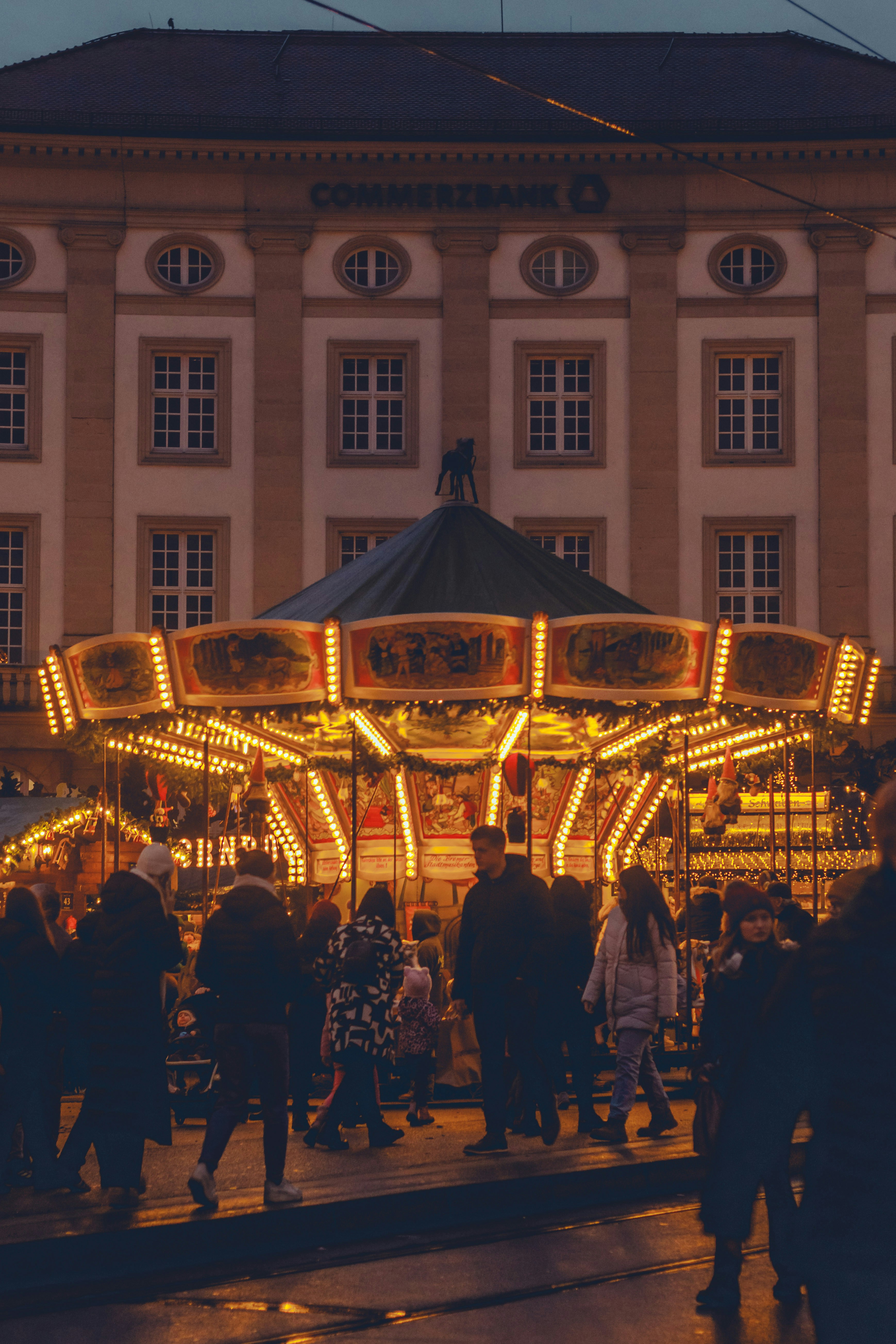 Golden Carousel Glow under a Historic Facade