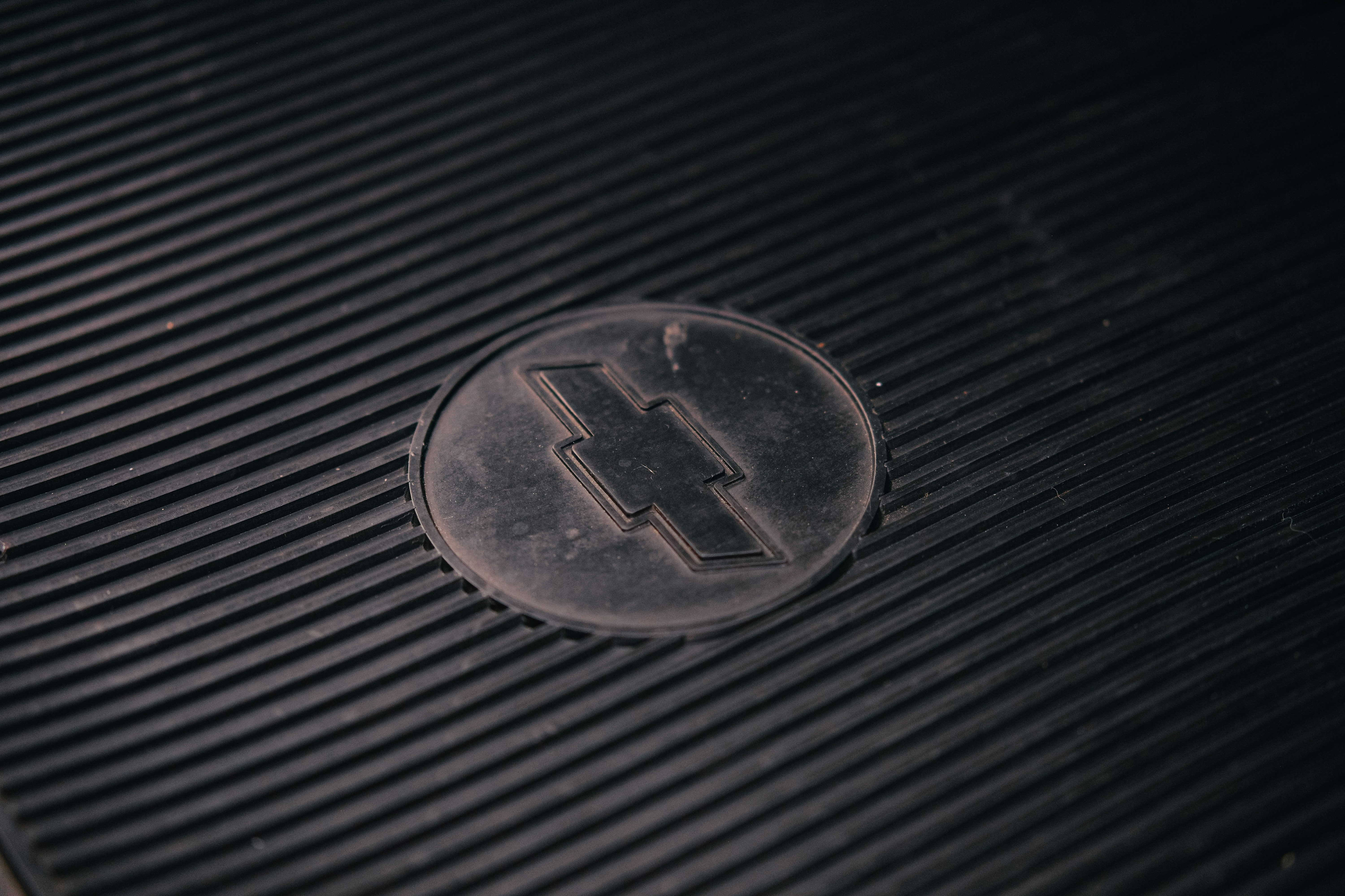 Metallic logo on grooved surface: a close-up of a gear-like emblem