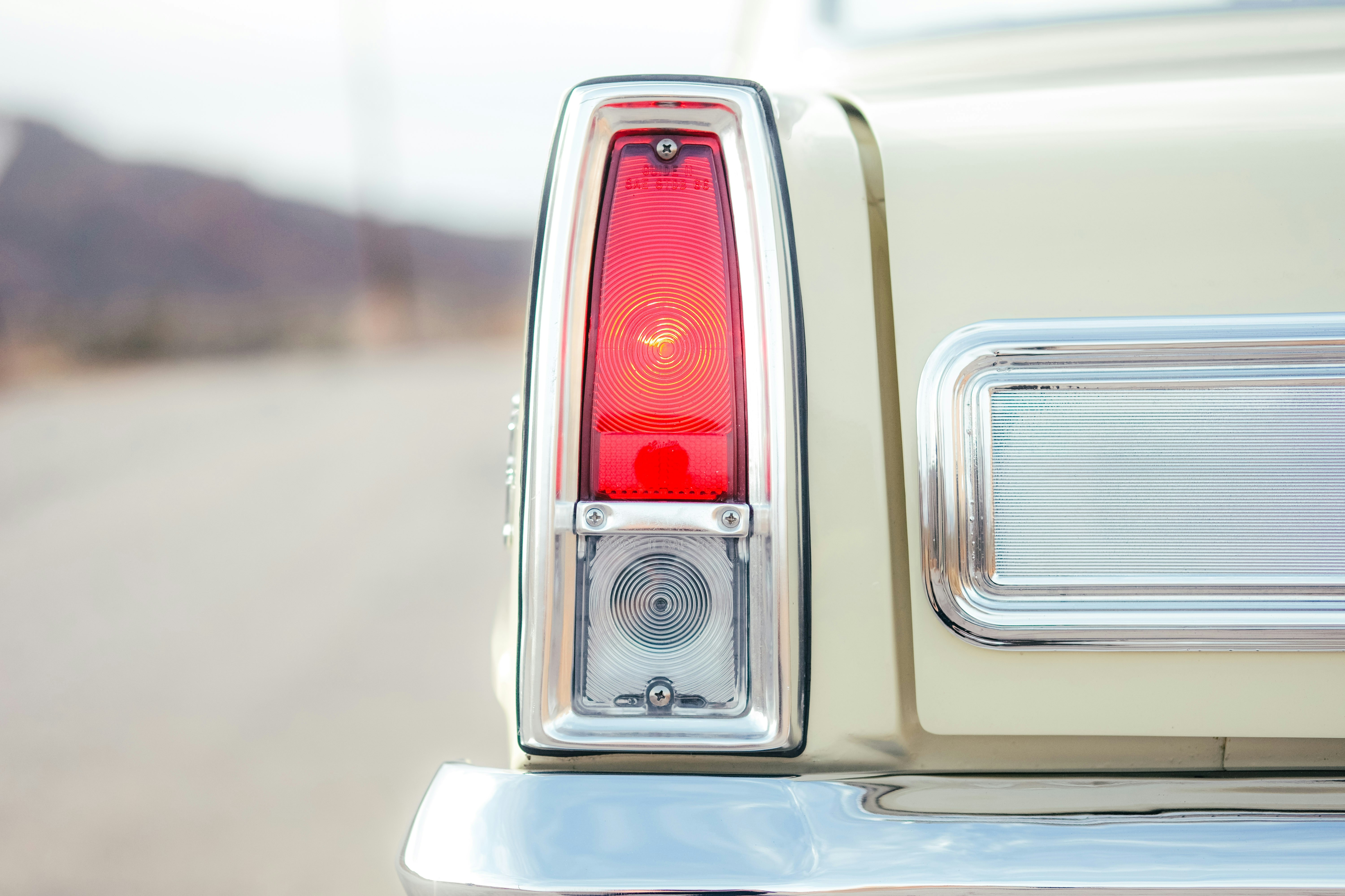 Tail Light Glow: A Desert Road Snapshot of Vintage Chrome