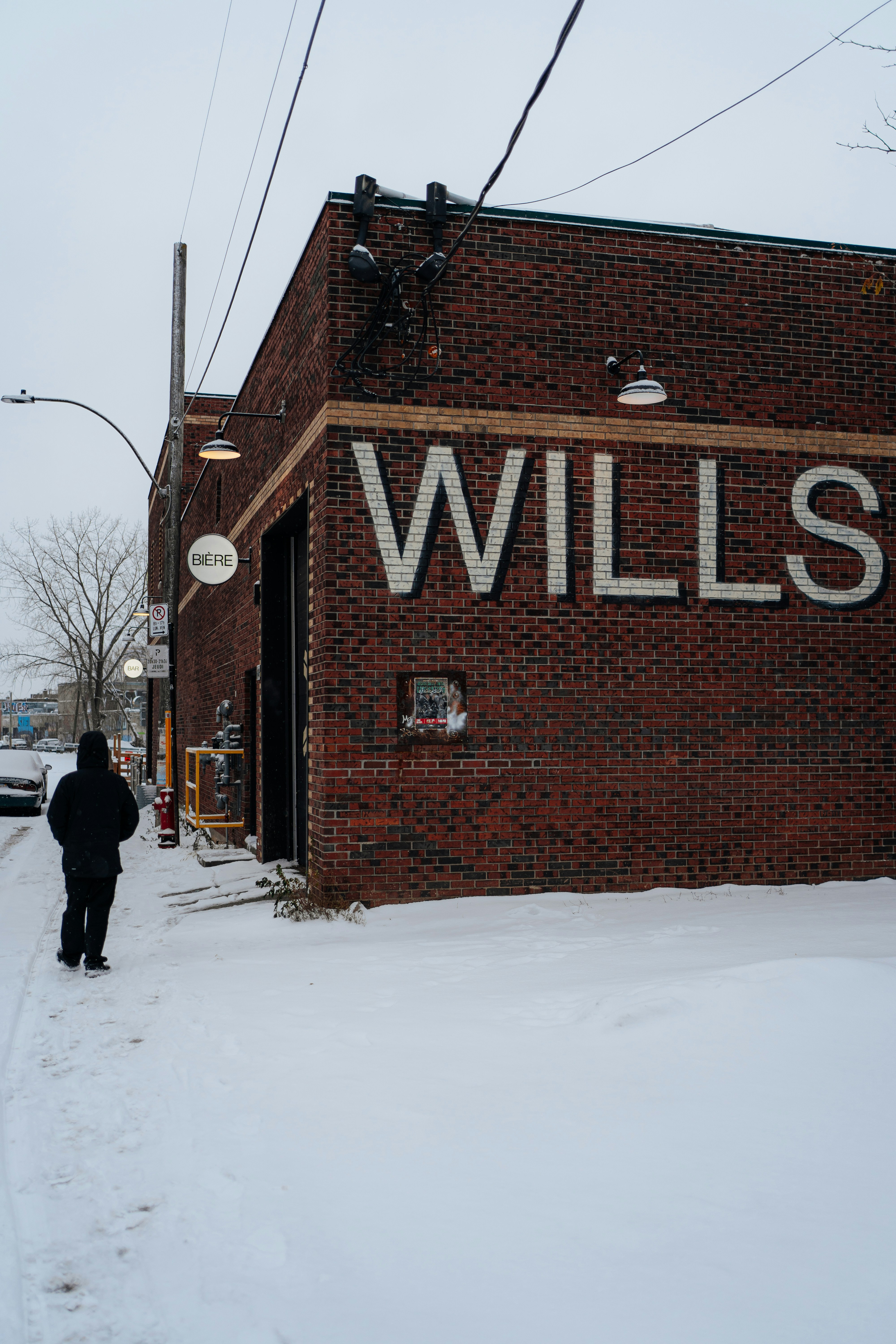 Brick Corner: A Snowy Street scene near the Will's sign