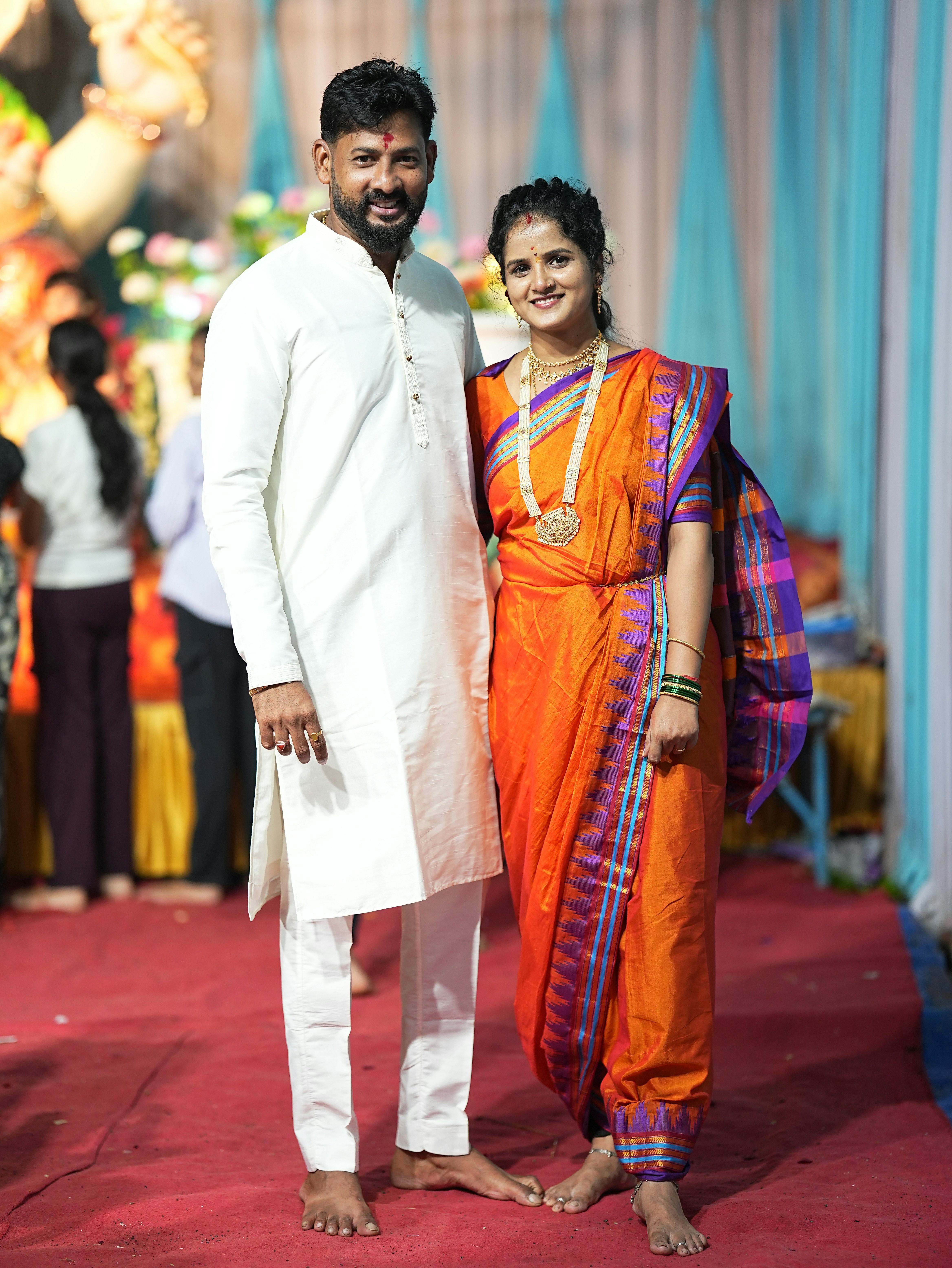 Joyful Union: Traditional Attire Framing a Couple at a Festive Event