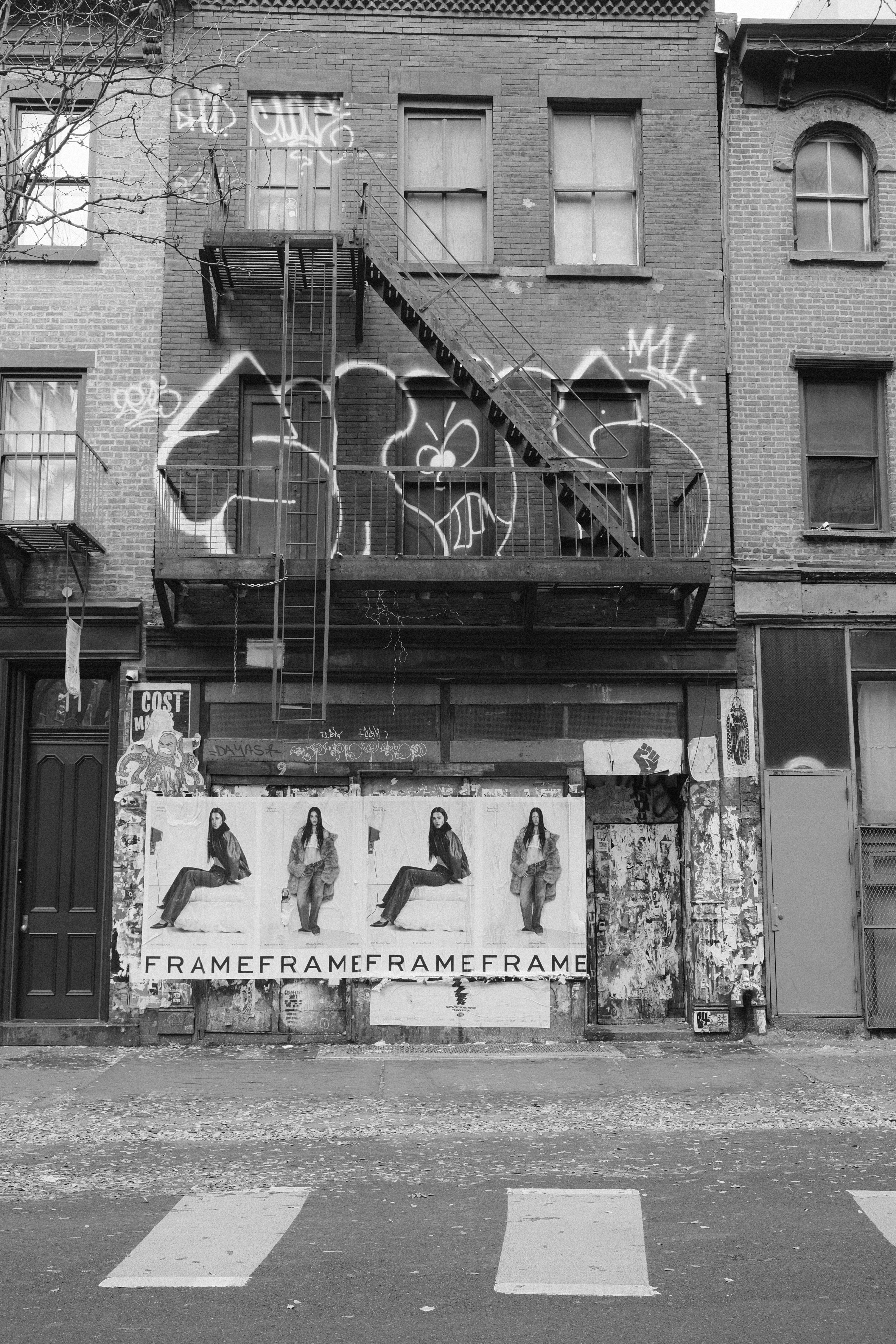 Graffiti-blanketed Fire Escape Frontage with Repetitive Posters