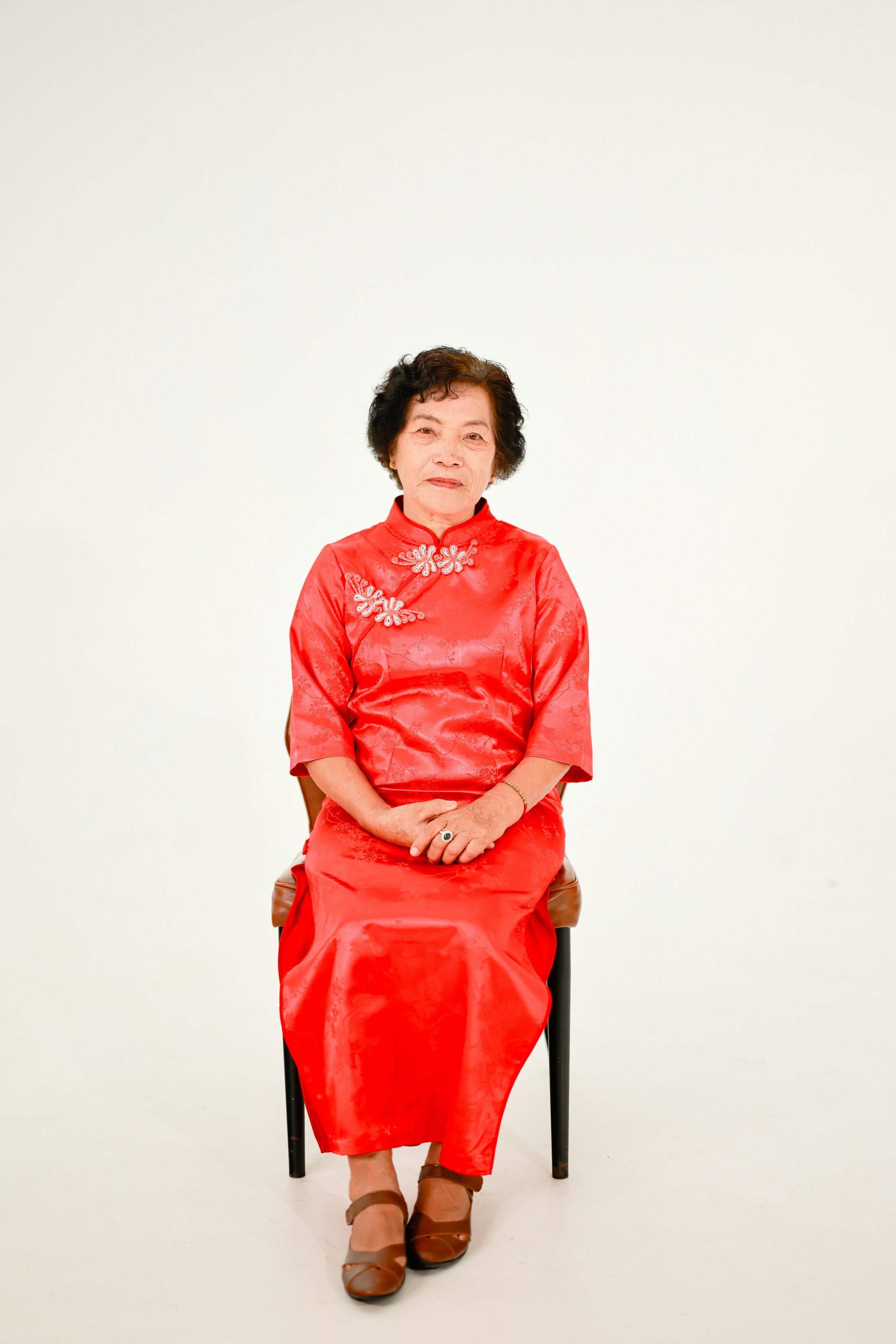 Red Silk Simplicity: A Poised Portrait in Traditional Attire