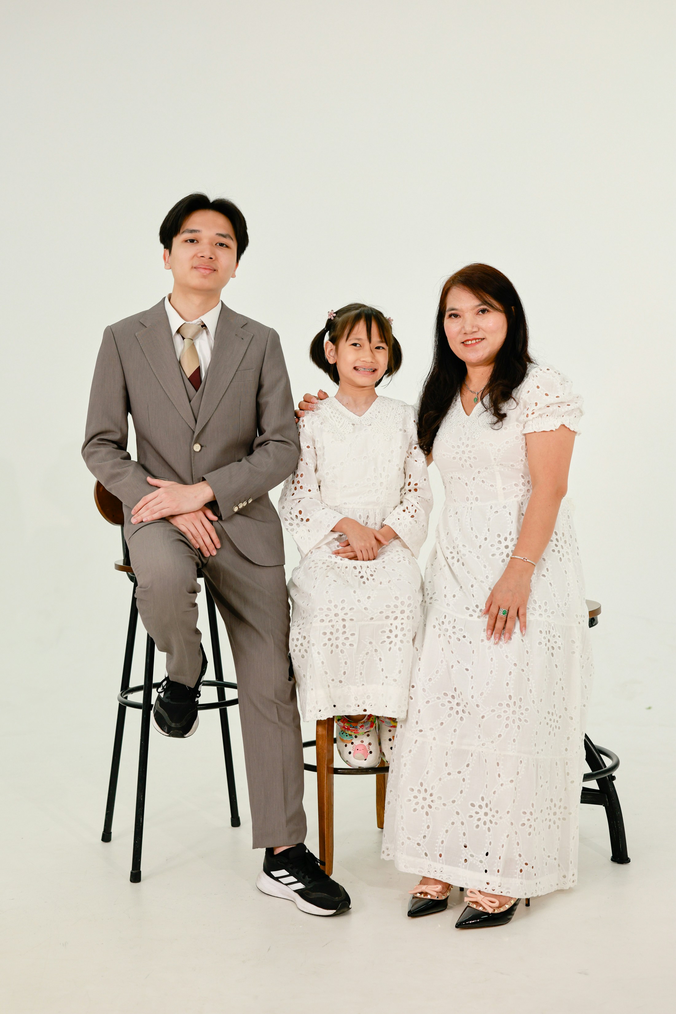 Family Portrait in White: A Formal Moment Surrounded by Soft Light