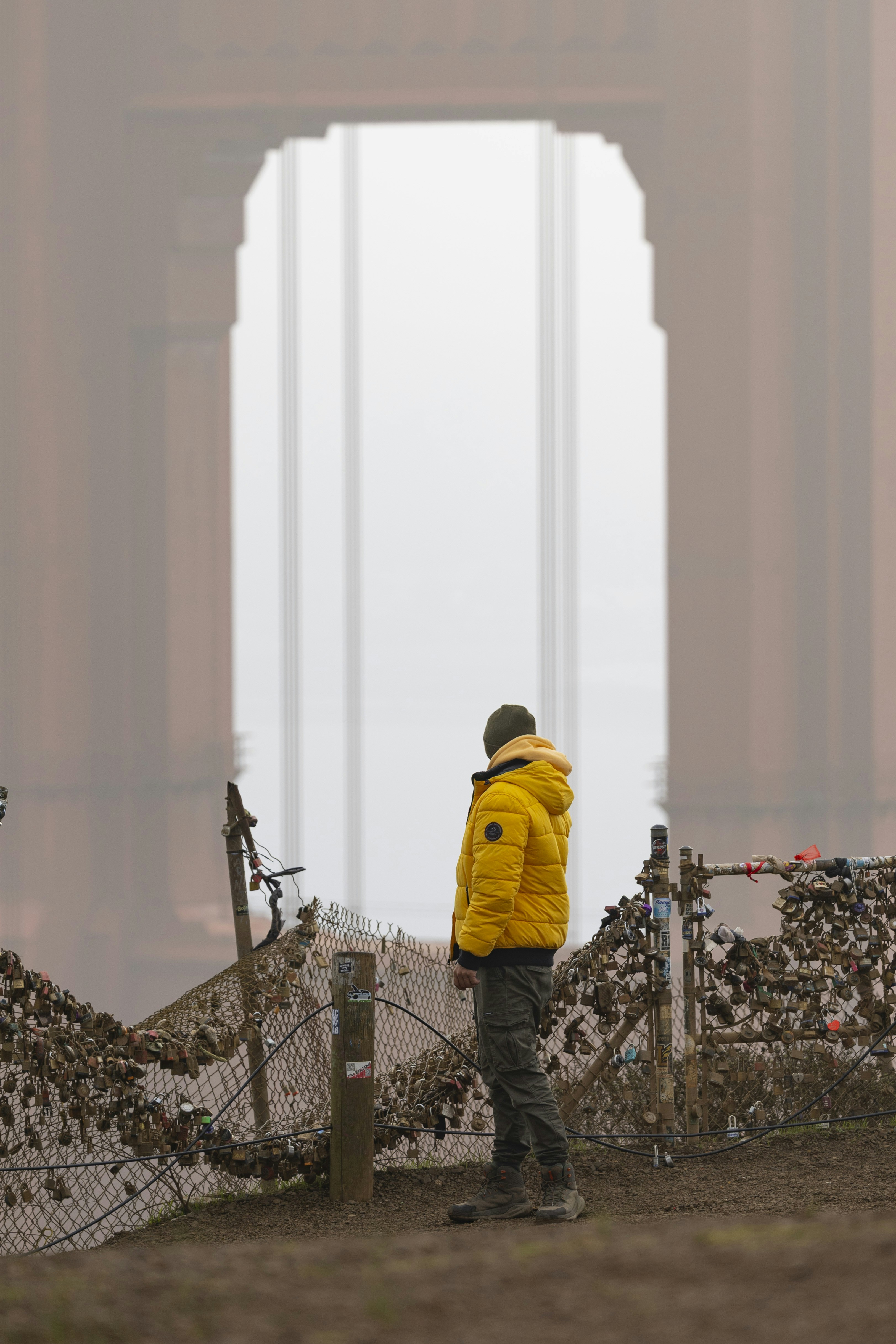 Bright Jacket on the Bridge: A Quiet Moment Amid Lock-Chain Silence
