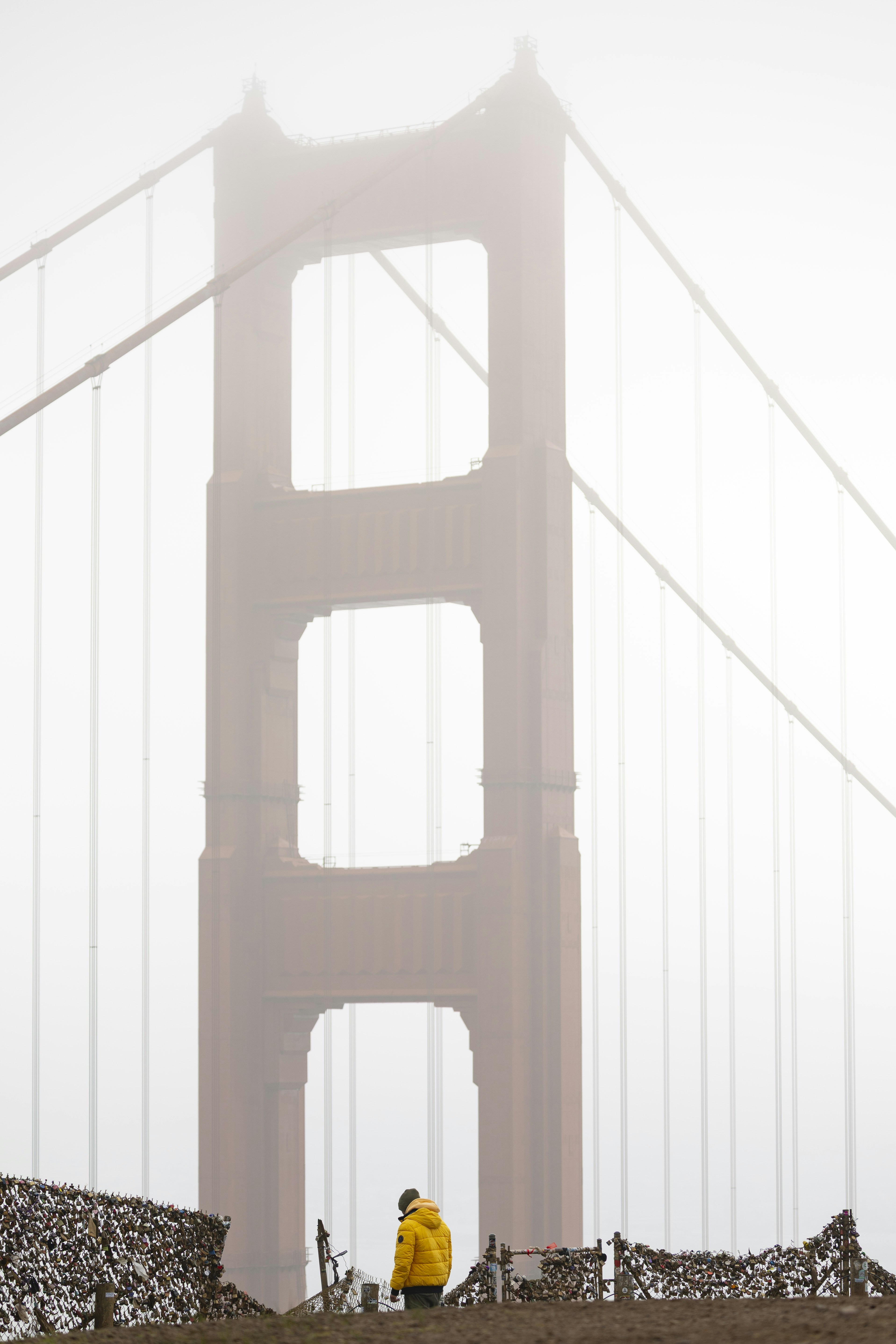 Golden Gate Silence: A lone figure in the fog at the edge of the bridge