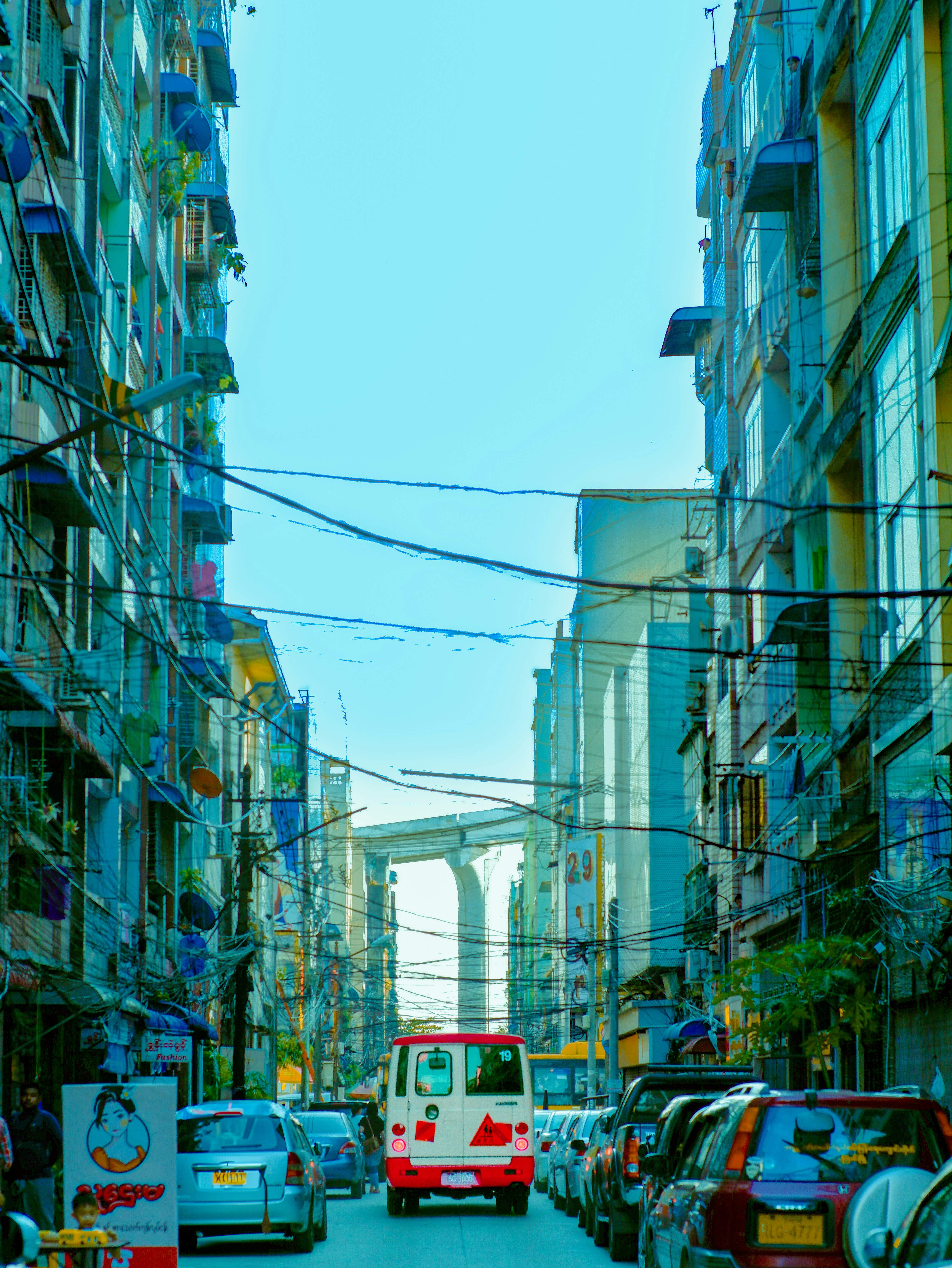 Urban Corridor: Neon-lit Street Receding Toward a Distant Archway