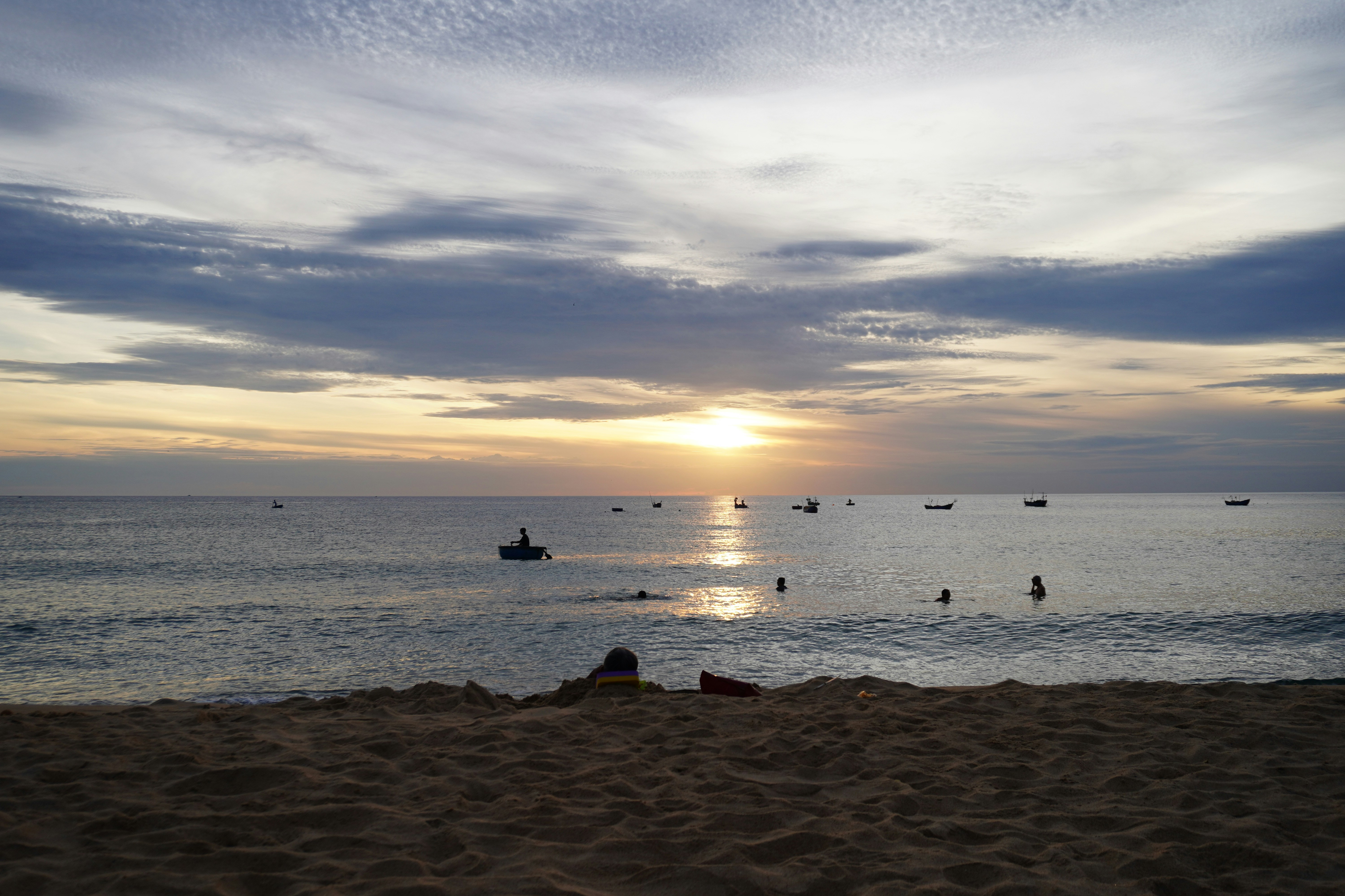 Dusk at the Calm Beach: Boats, Sand, and a Quiet Horizon