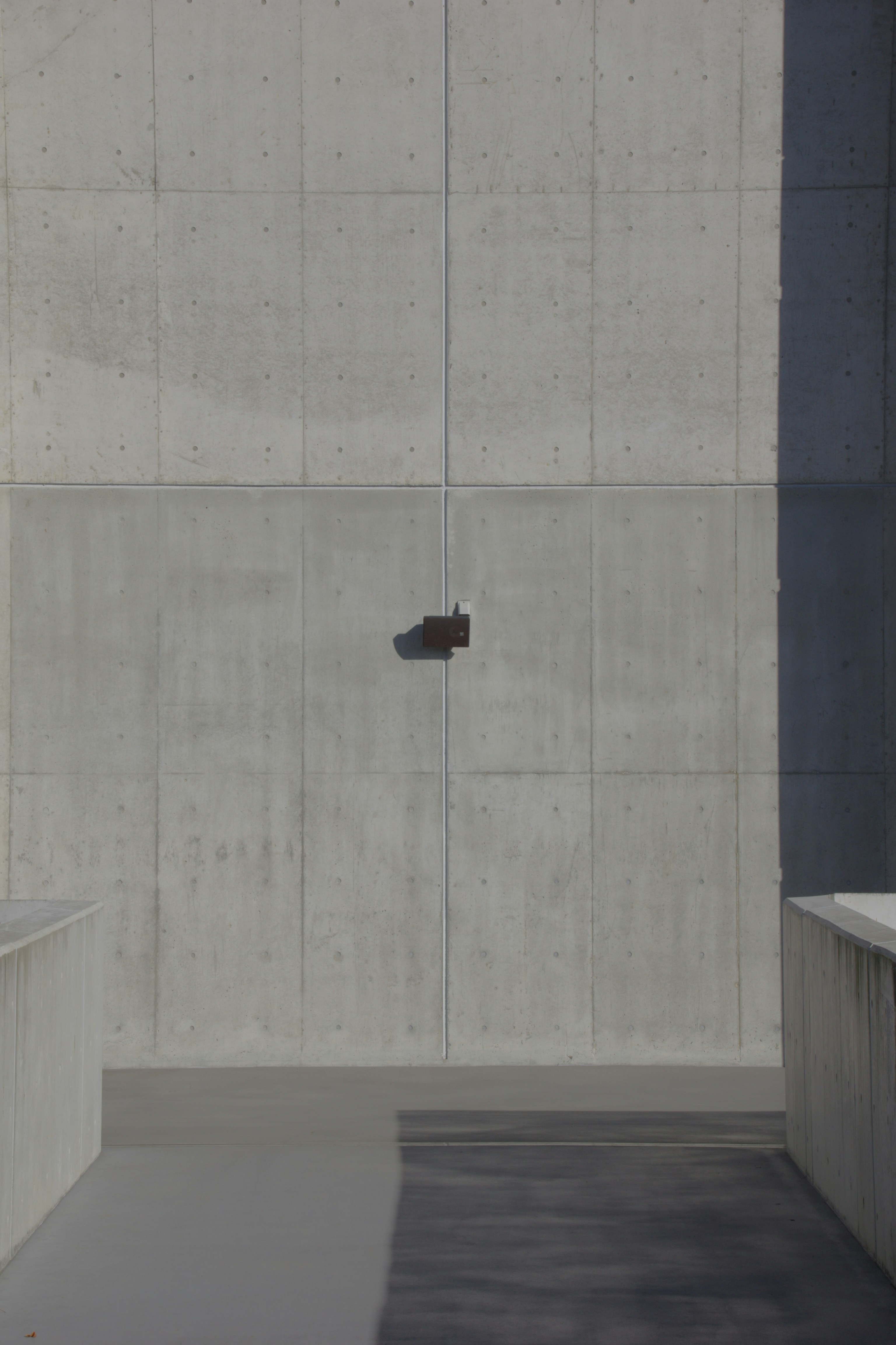 Concrete Monolith: A Minimalist Walkway Under Shadow
