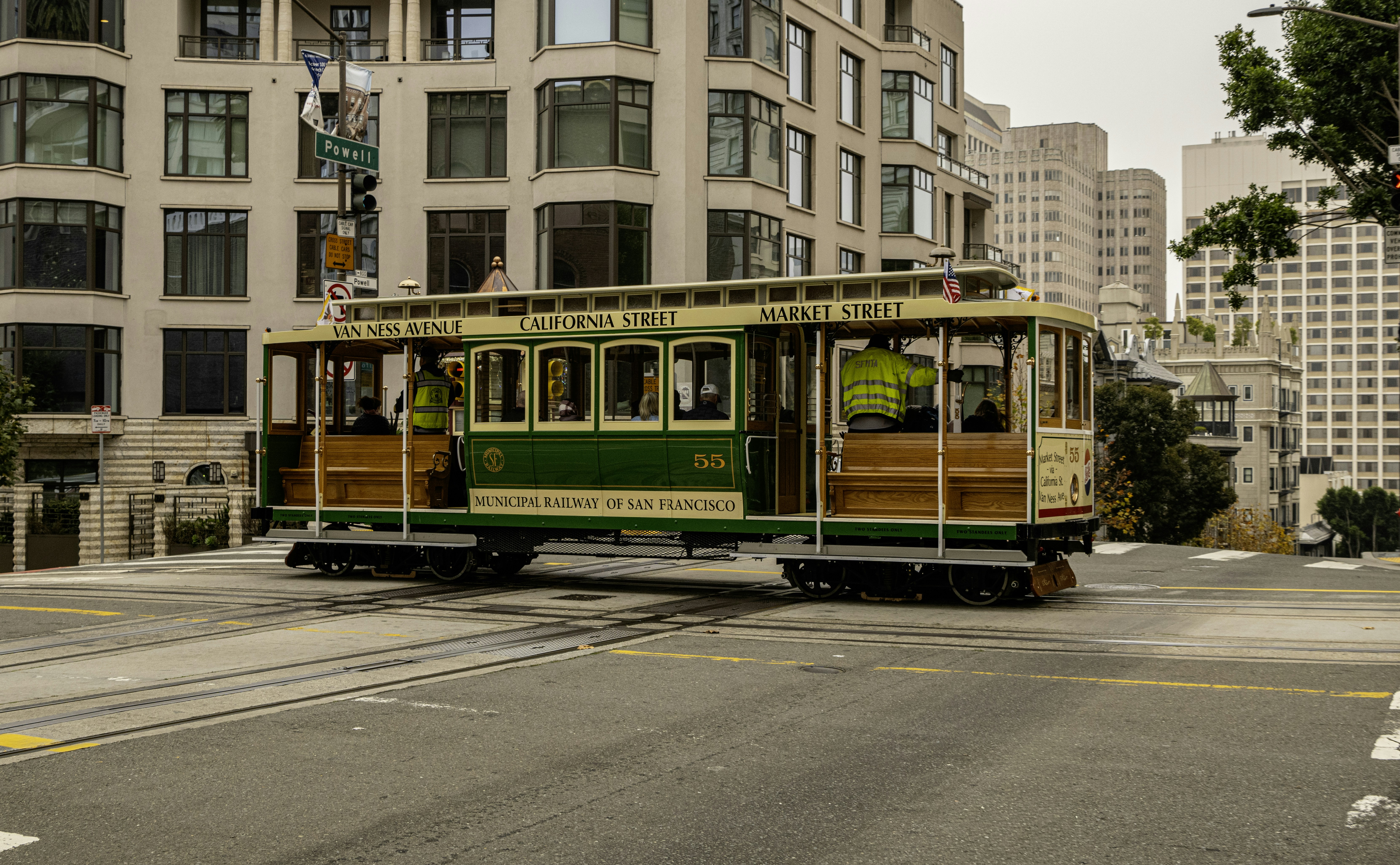 Historic trolley pauses at a sunlit street in San Francisco