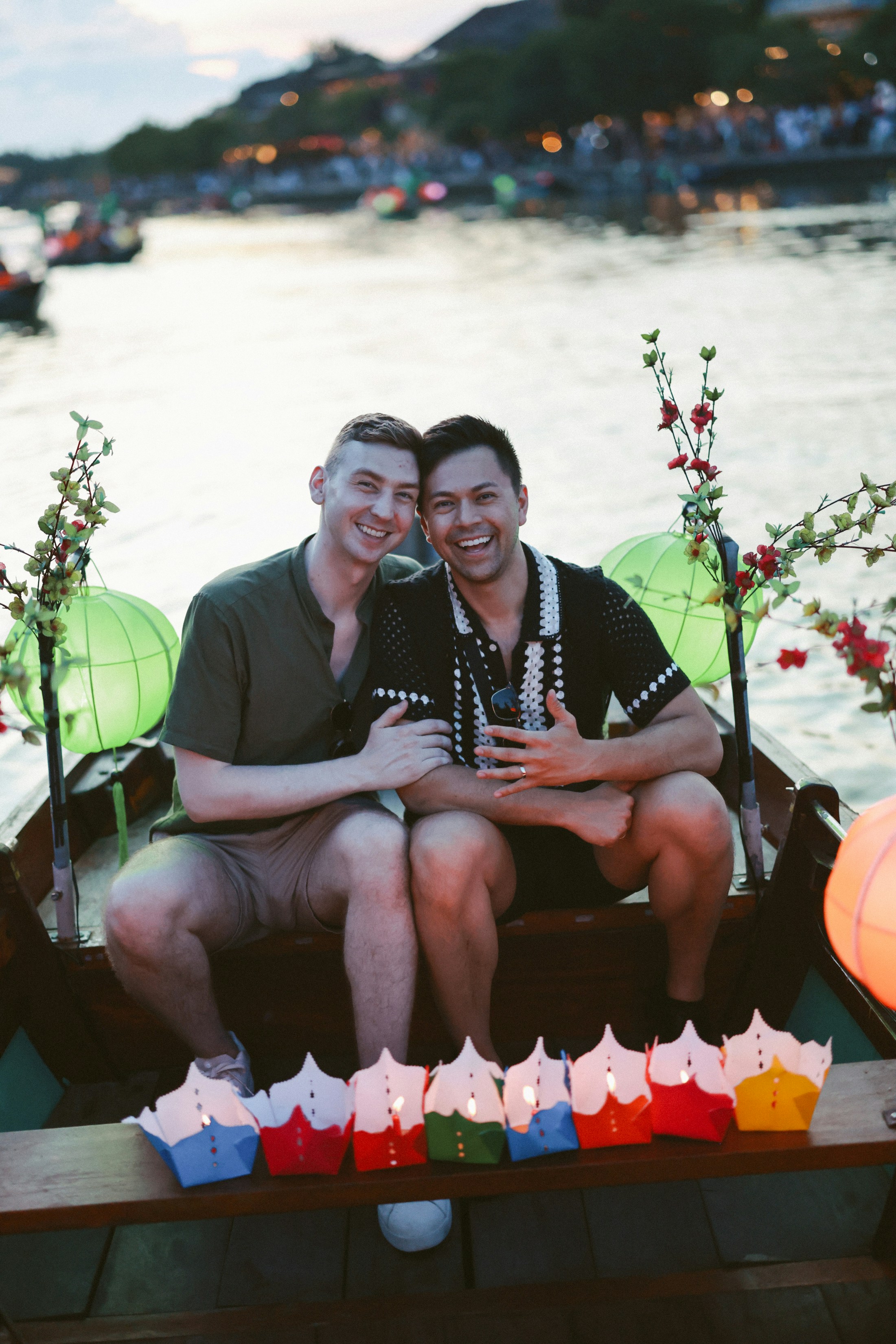 Two friends at sunset boat parade share a warm moment