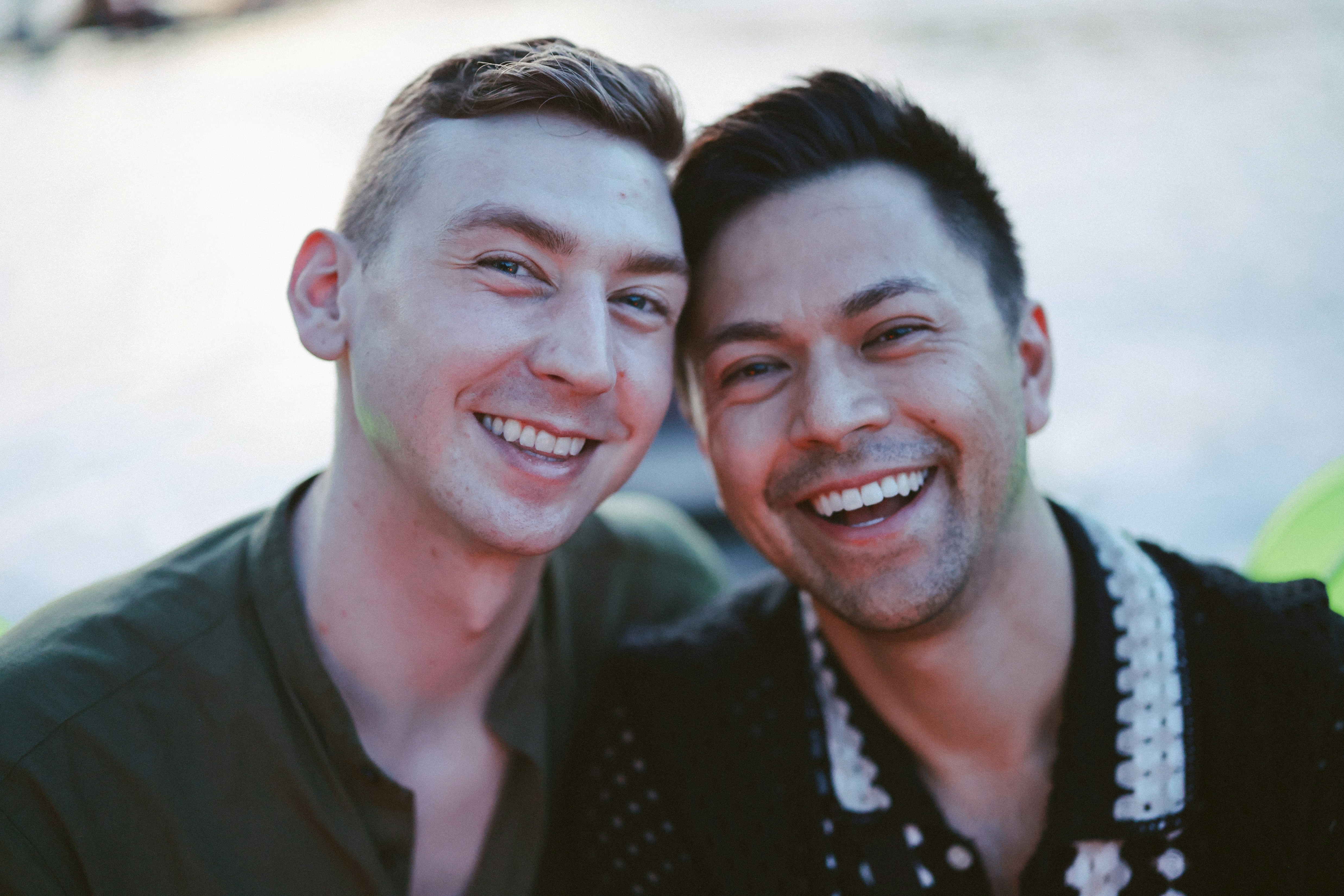 Two friends, one moment: a sunlit portrait by the water