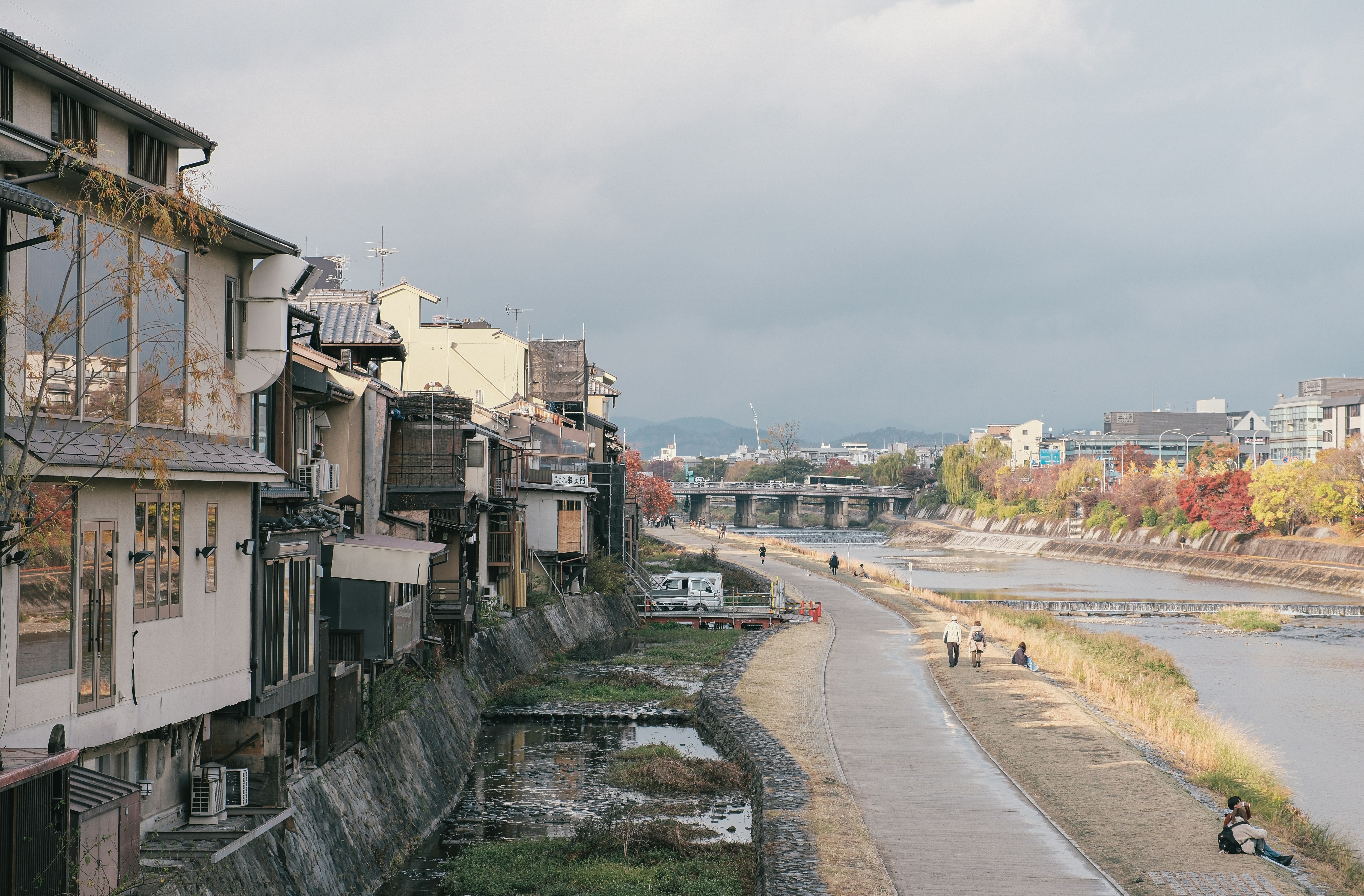 Riverside Alleyway: Quiet Streetcar Route Between Distant City Skies