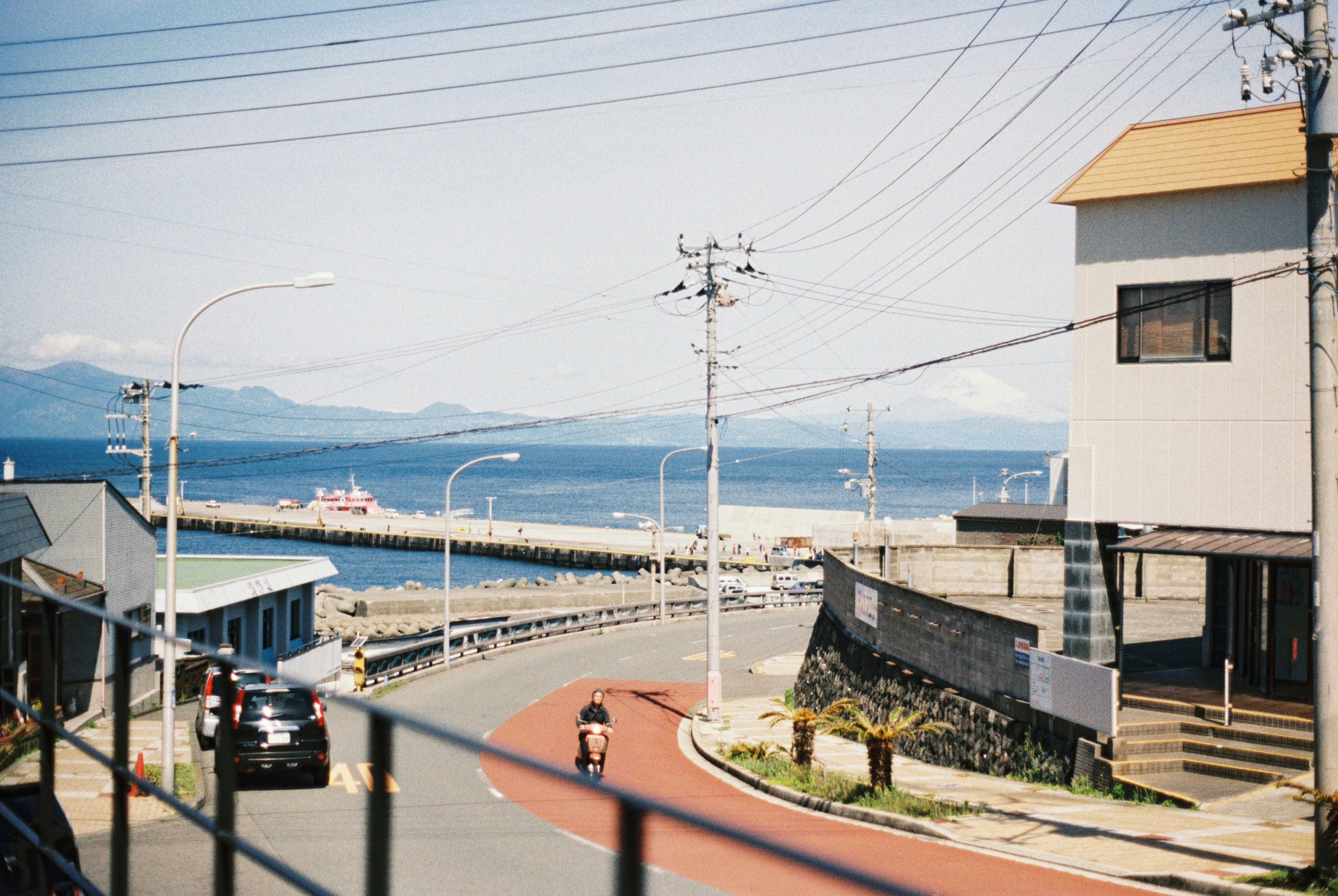 Coastal Road Bend: A Quiet Ascent Past the Harbor