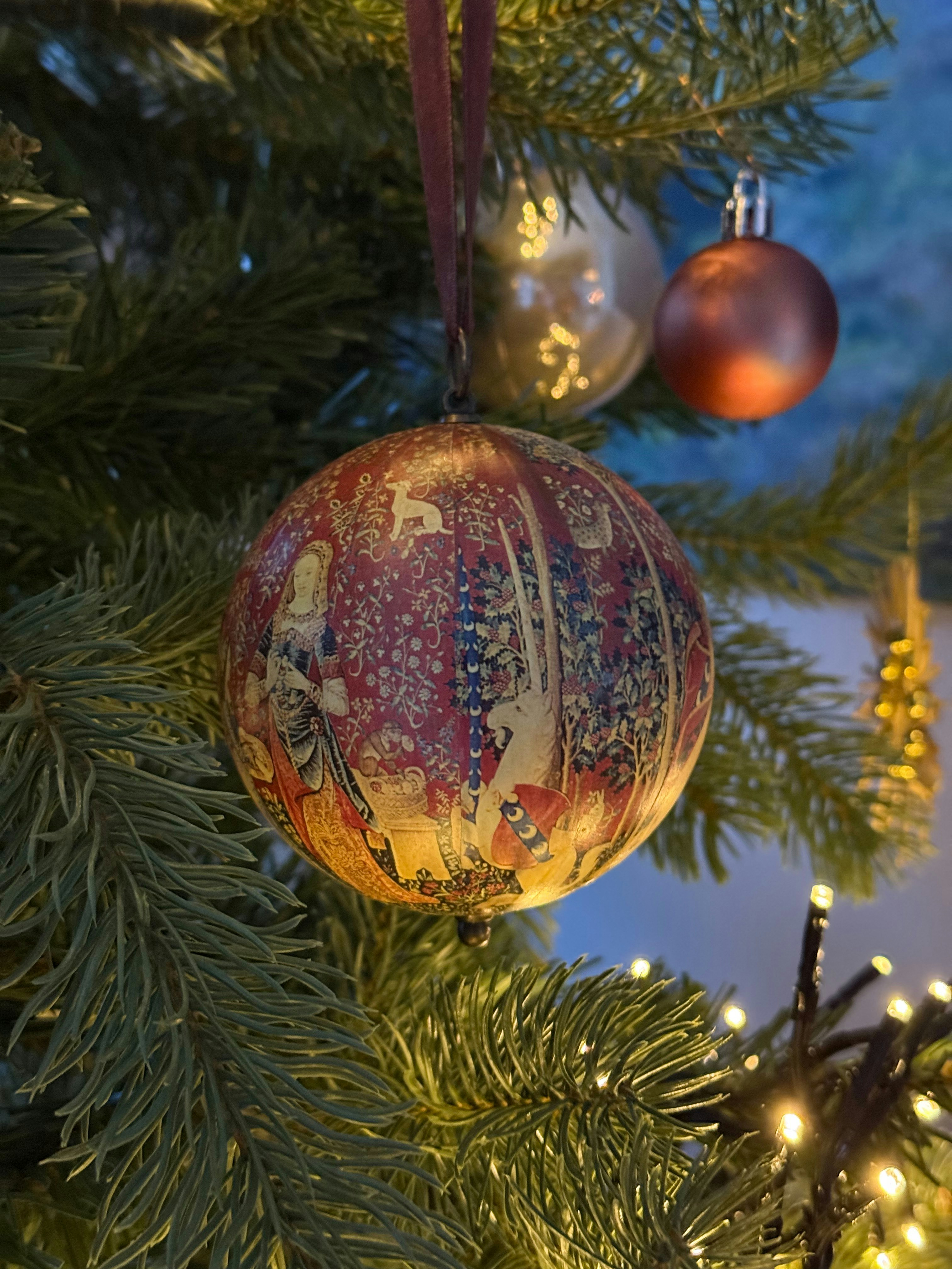 Ornate Christmas Bauble Anchored by Evergreen Pines