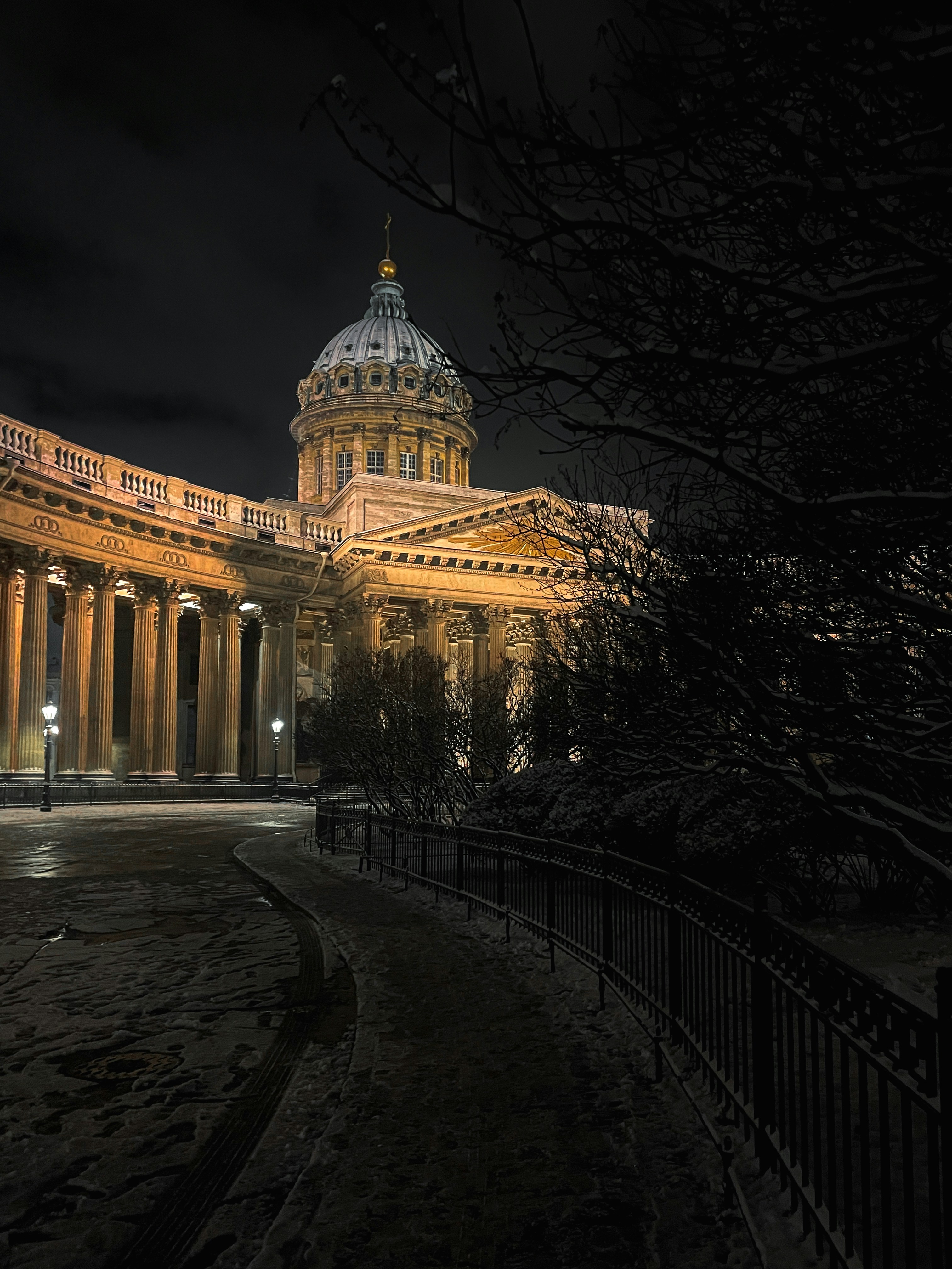 Illuminated domed façade under dark sky, Parisian-inspired neoclassical avenue