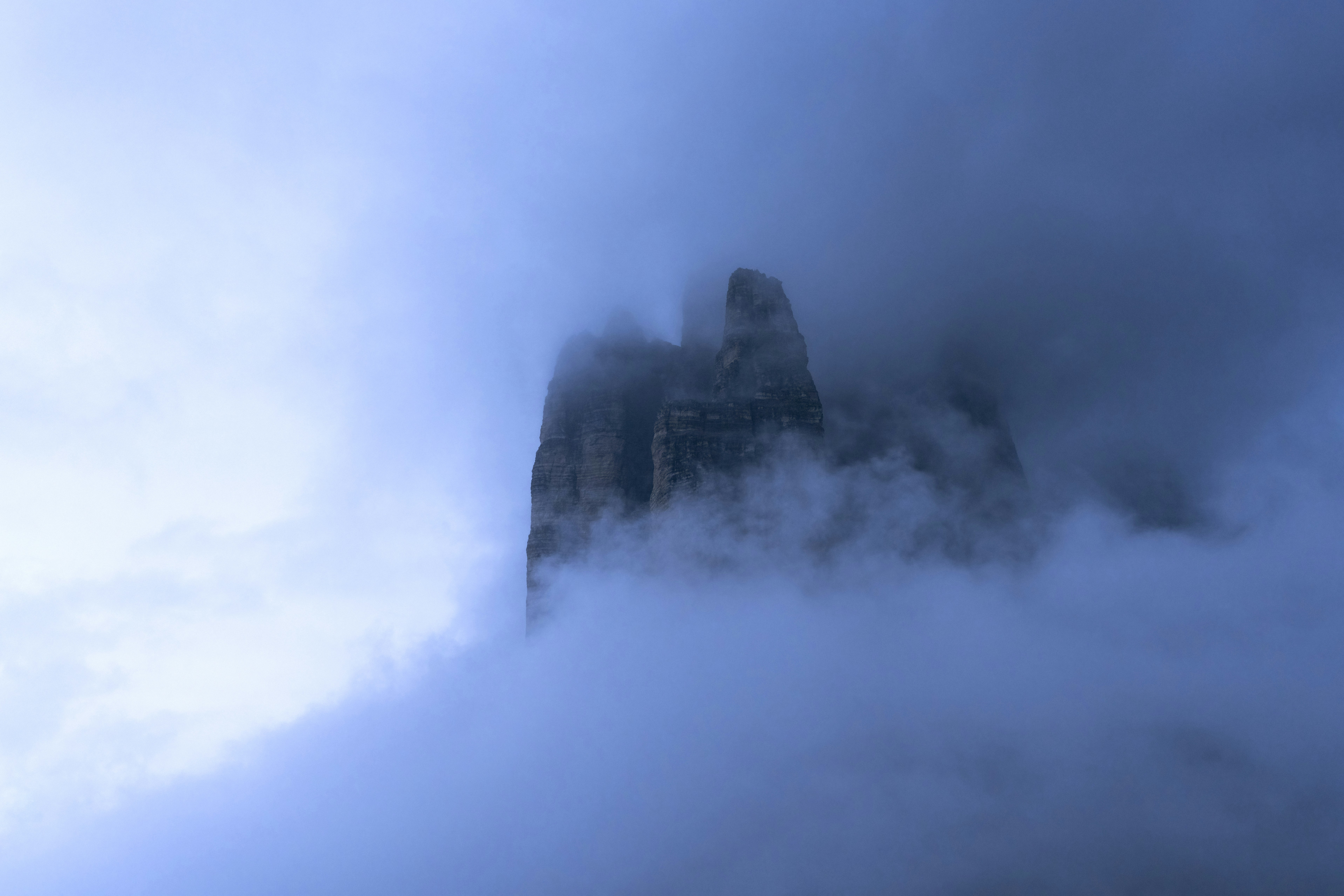 Mist-Clad Peak Emerges Through the Clouds