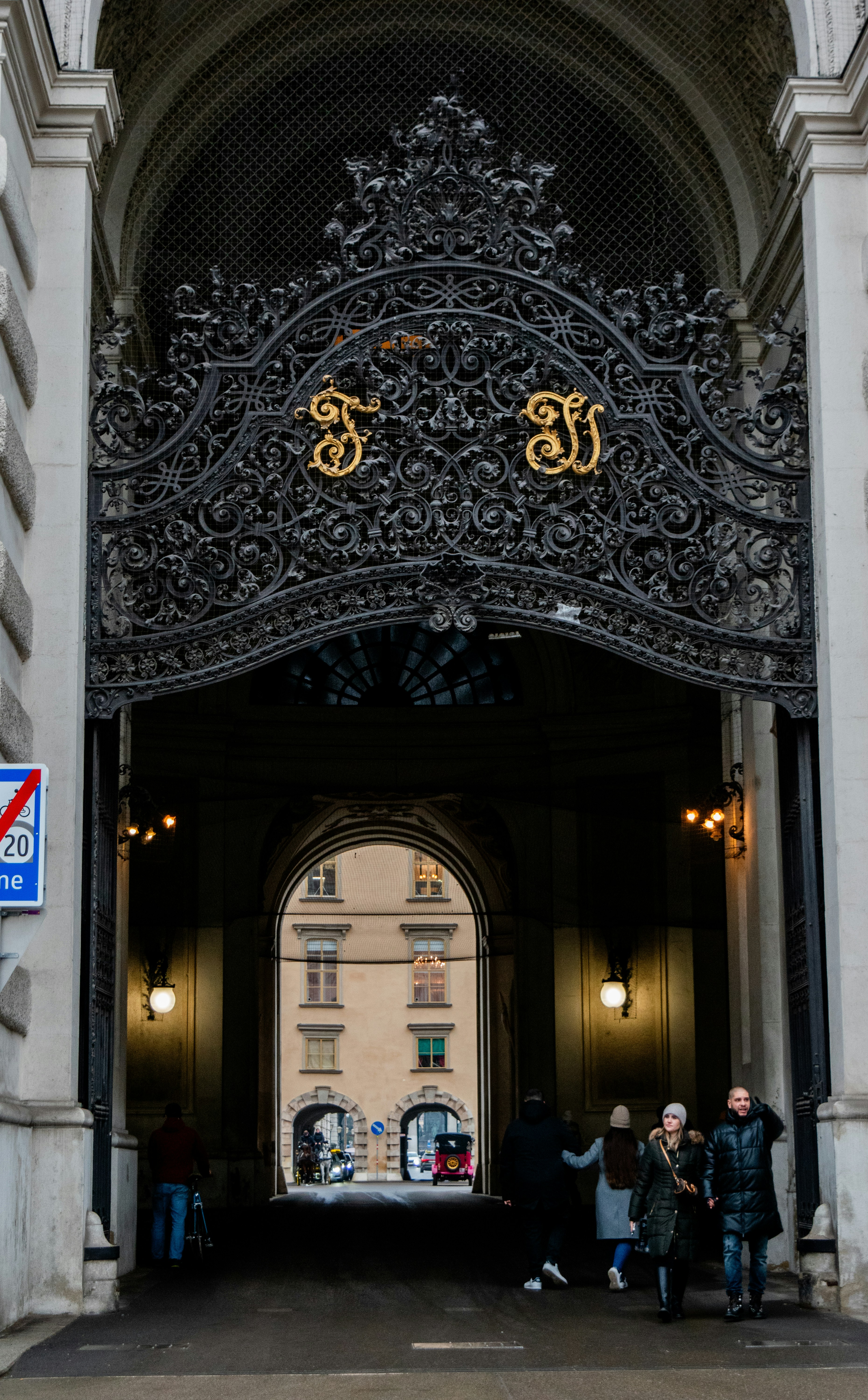 Ornate Gate Inward: A Museum Arch Framing Passersby