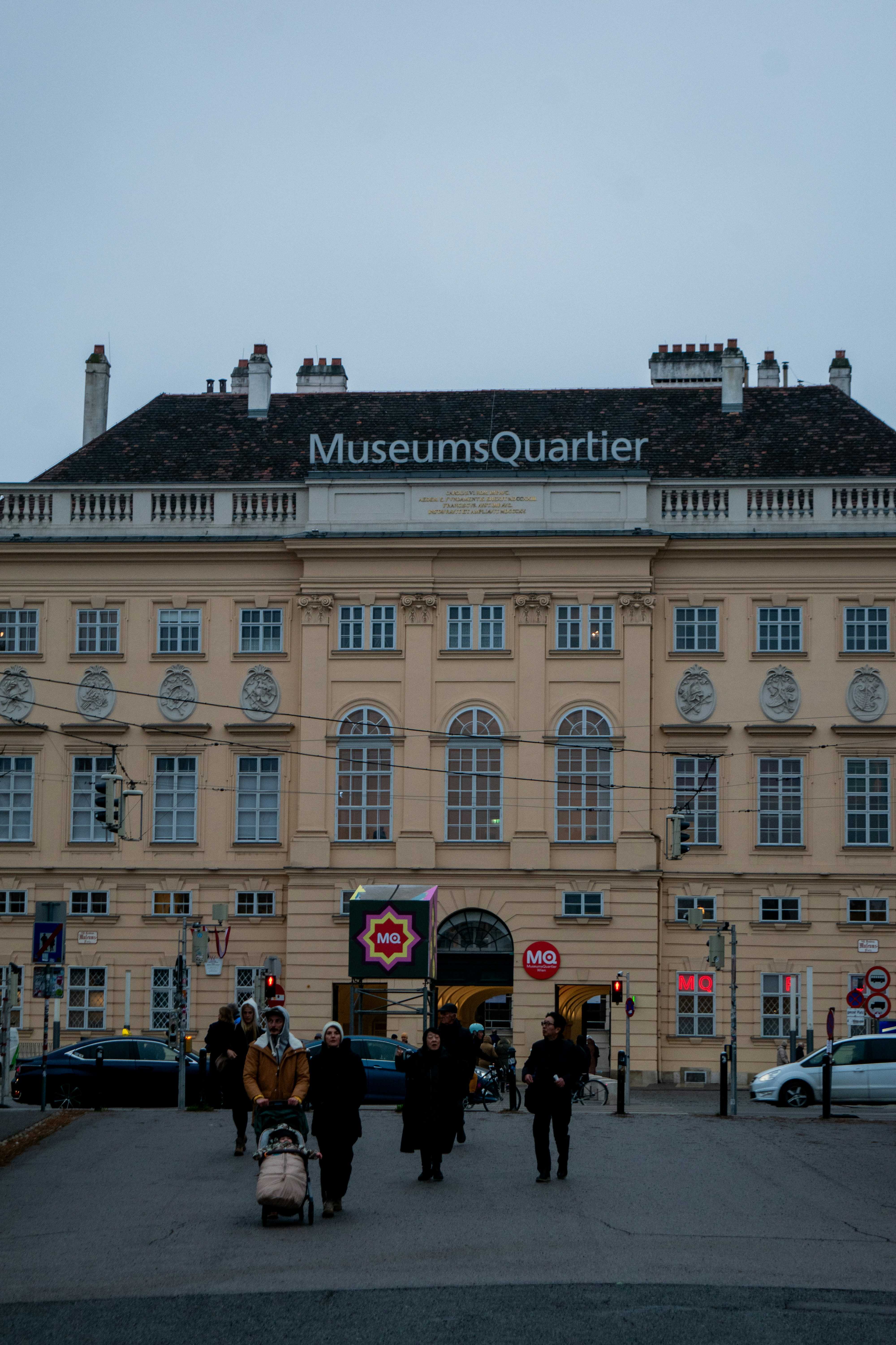 MuseumsQuartier Forecourt: People Crossing the Grand Entrance