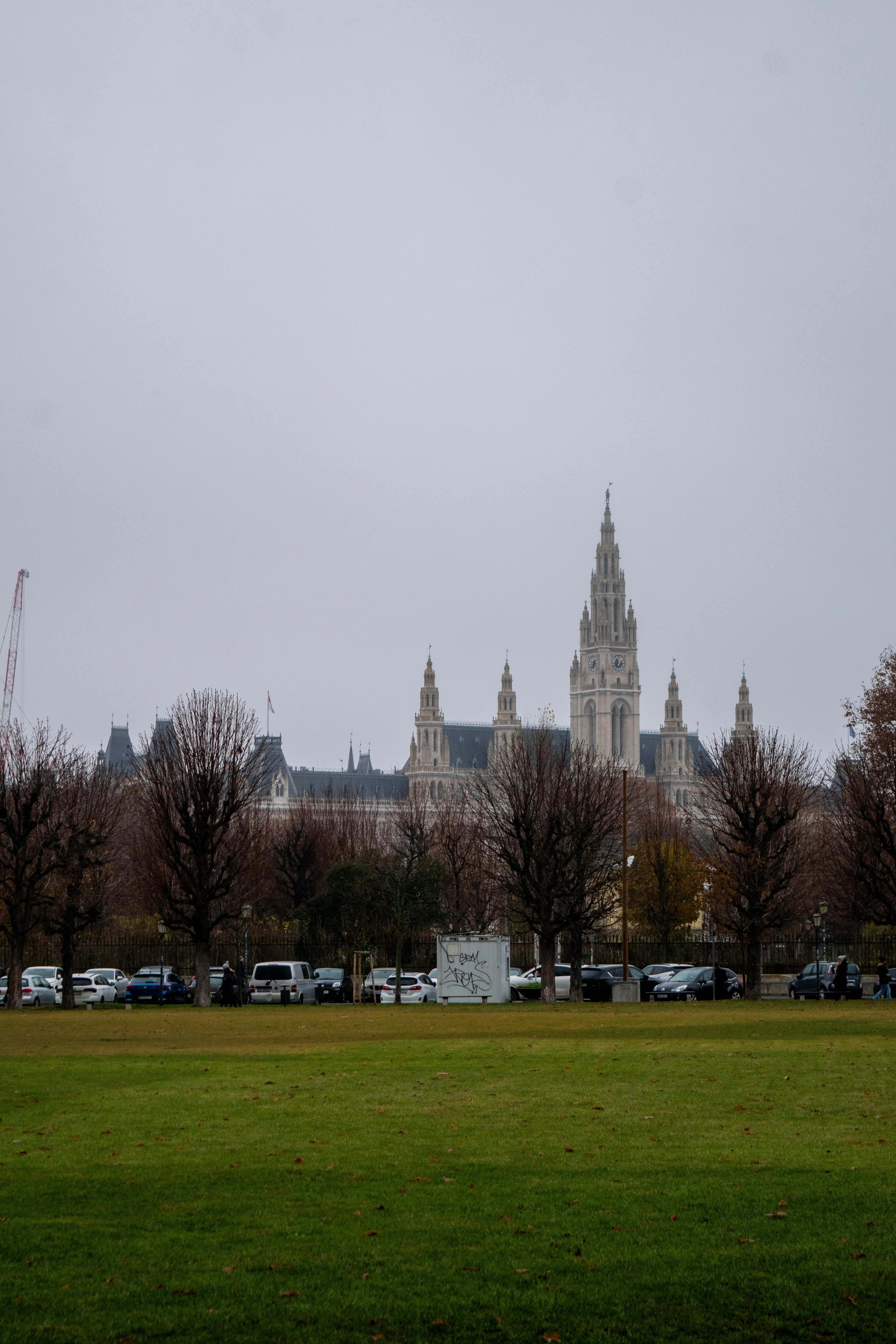 City skyline framed by bare trees and a distant grand spire