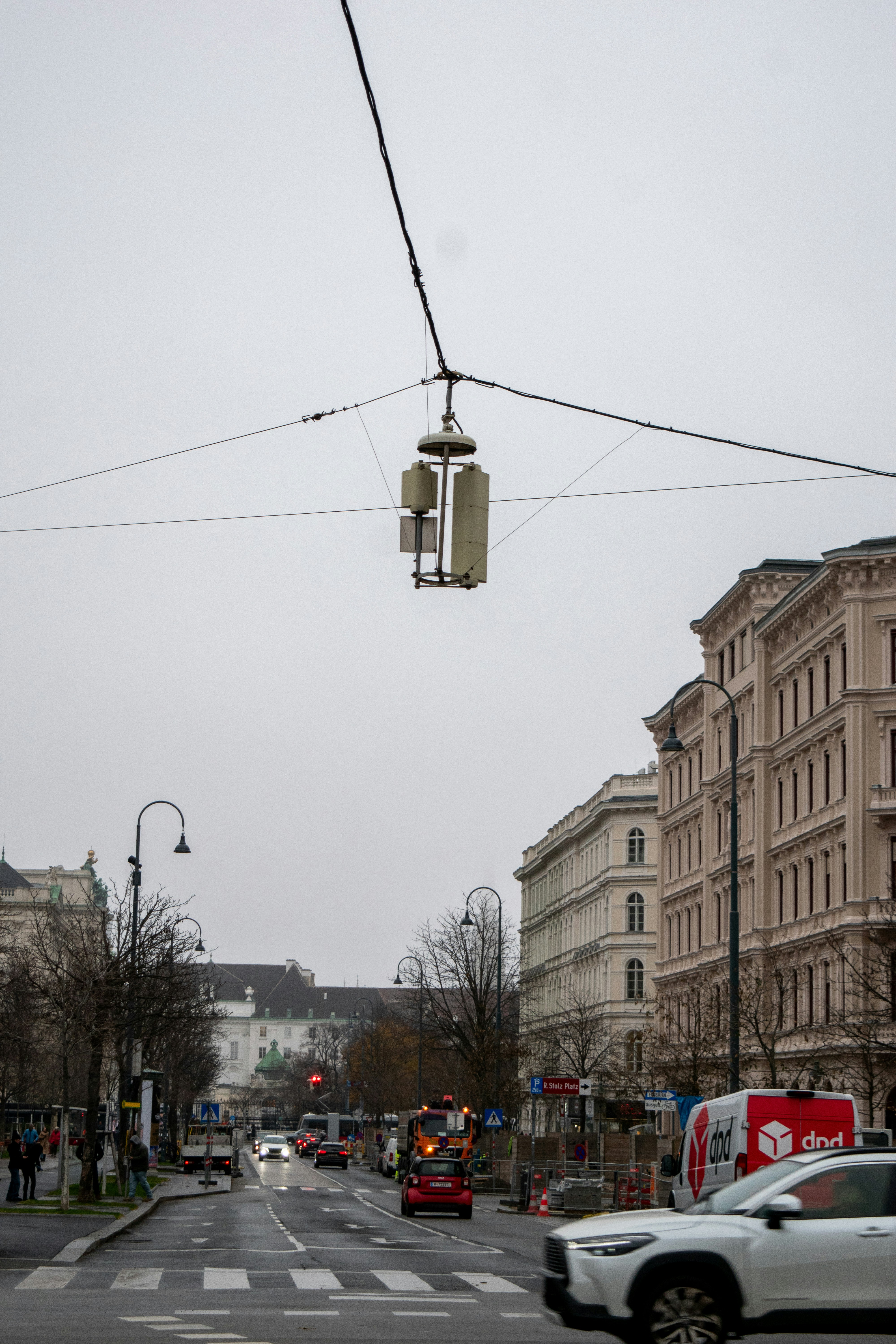 Street scene with buildings, cars, and overhead wires photo – Free ...