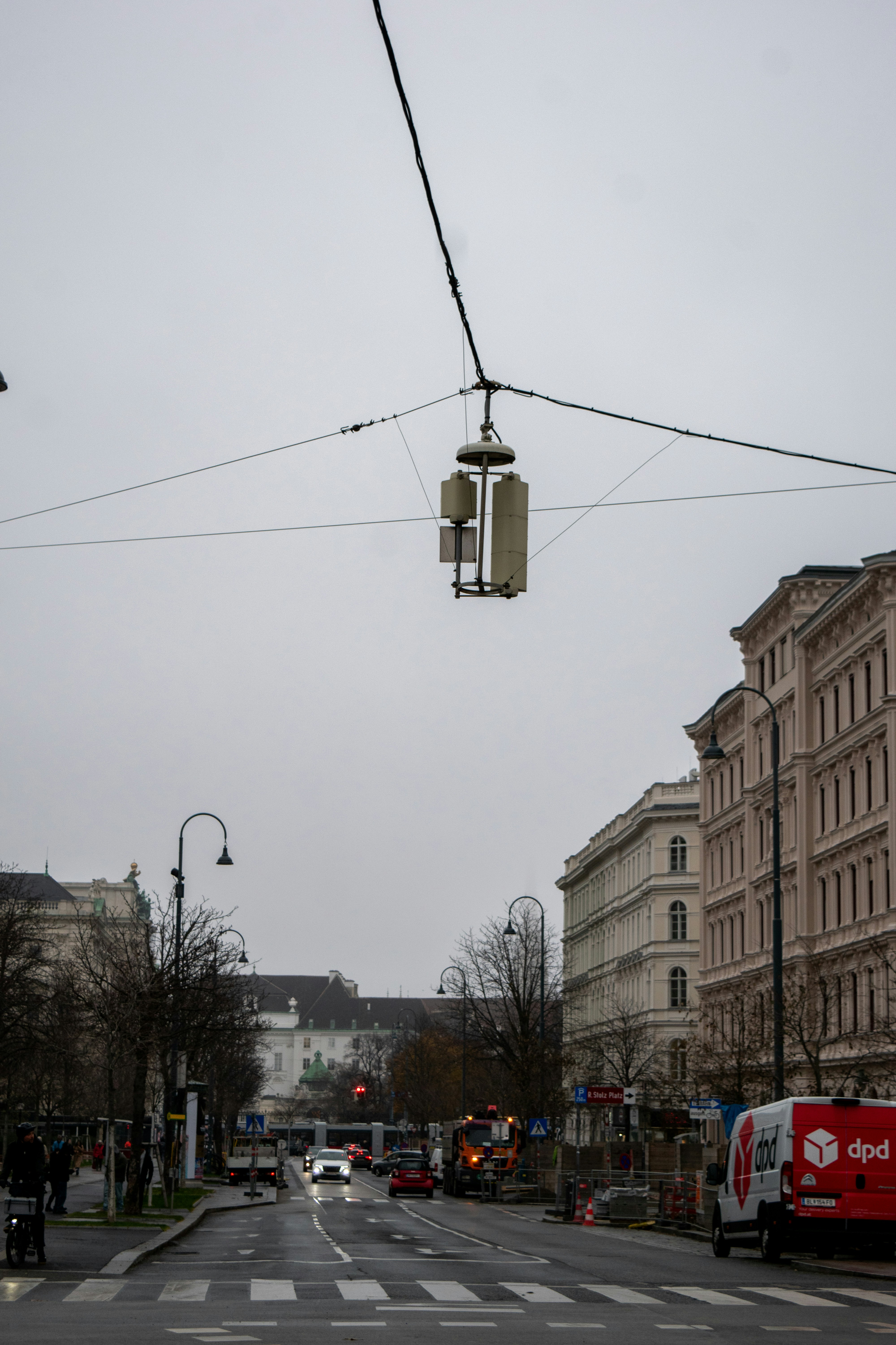 Suspended Transformer Over a City Street at Dusk