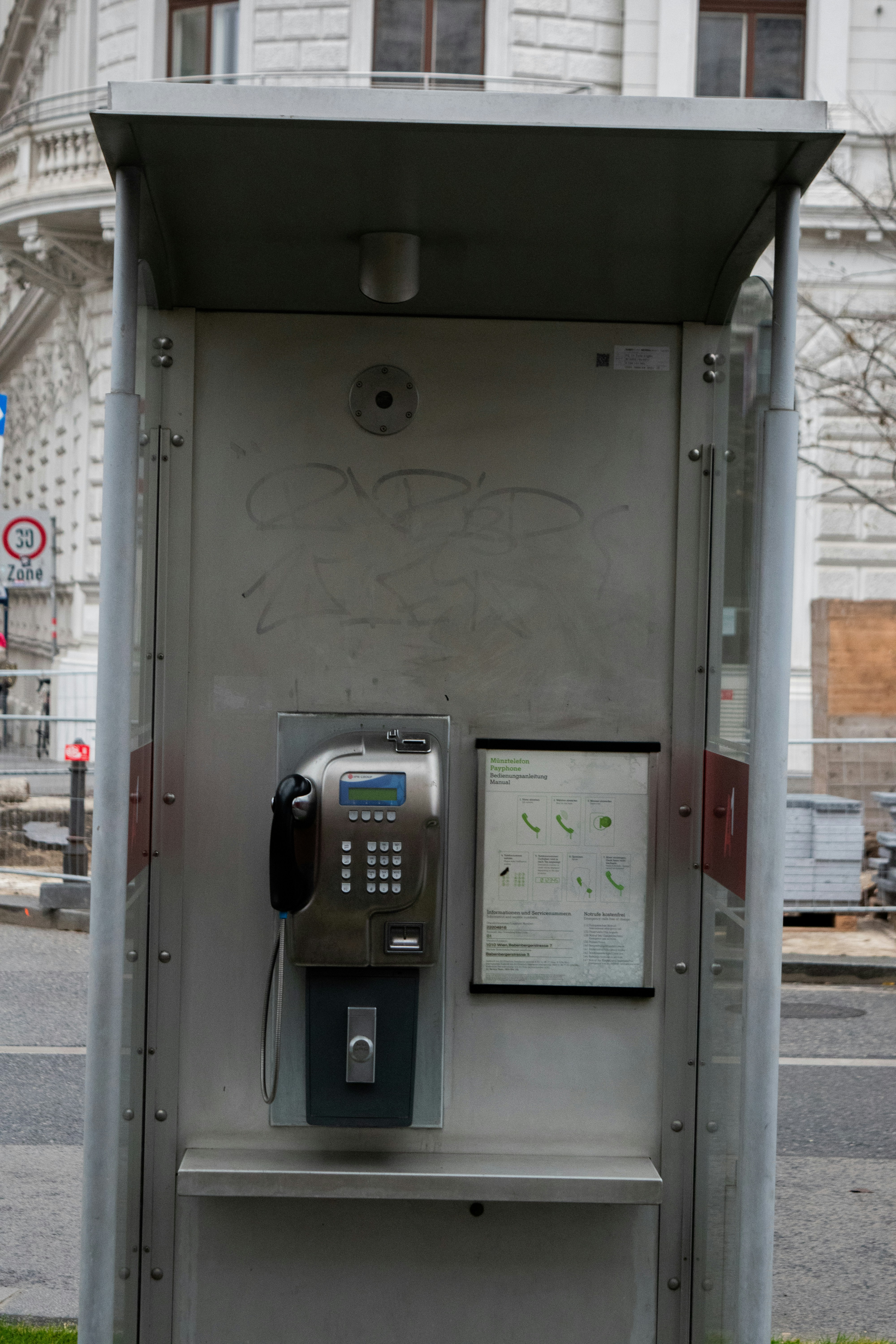 Public Payphone at a Quiet Urban Stop