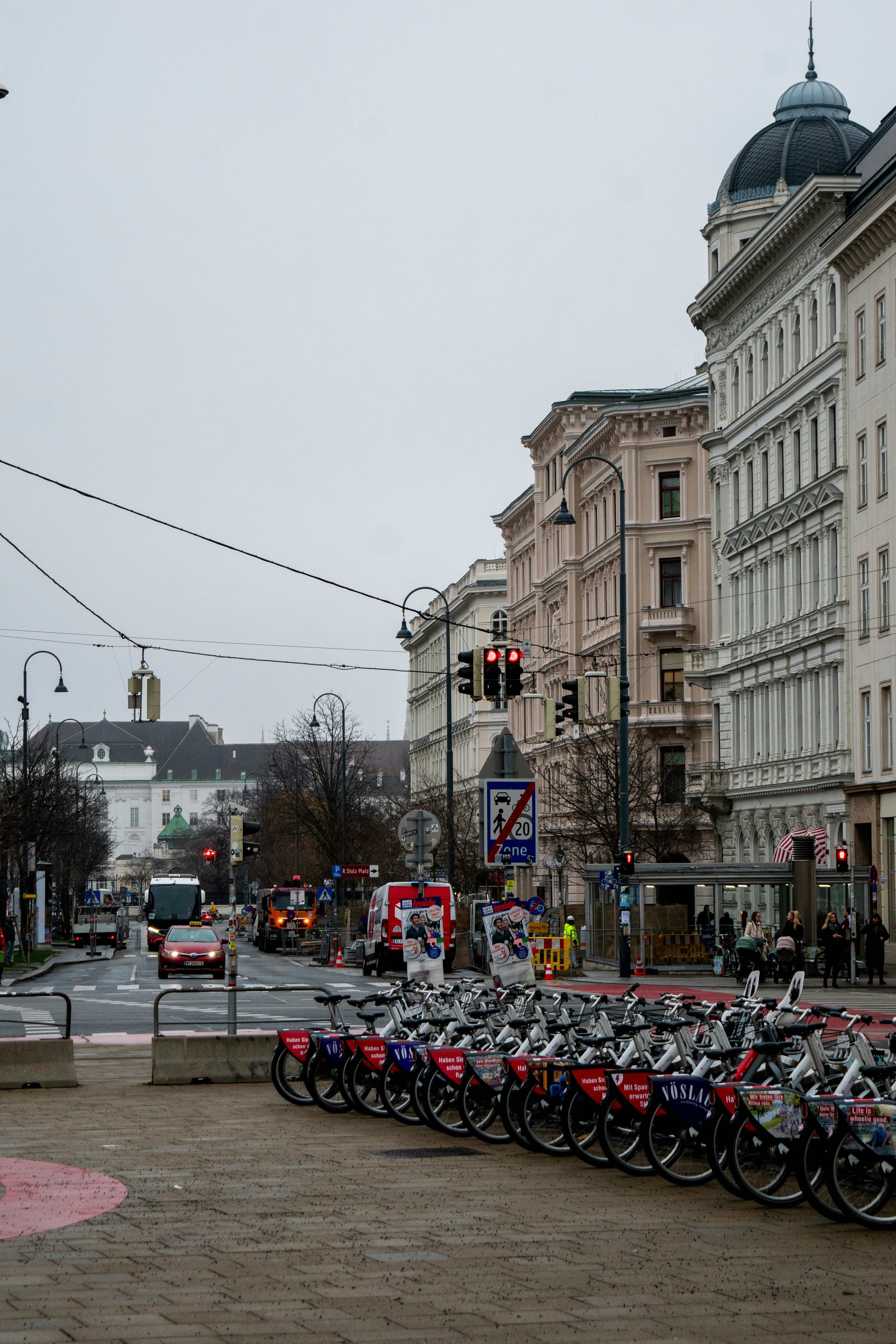 Urban Orbit: Bicycles and Historic Facades on a Rainy Street