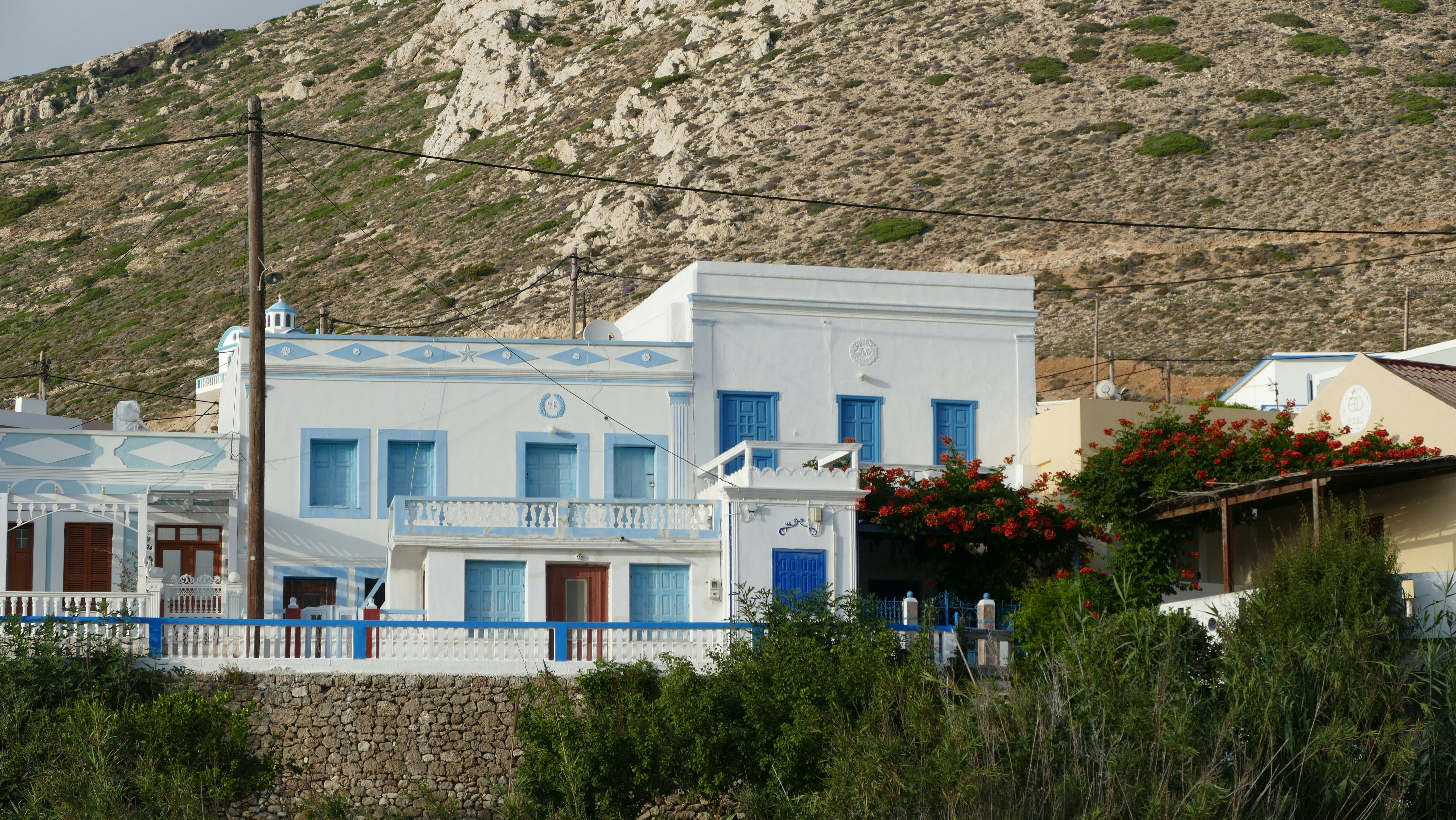 Beautiful Greek houses with typical blue window doors