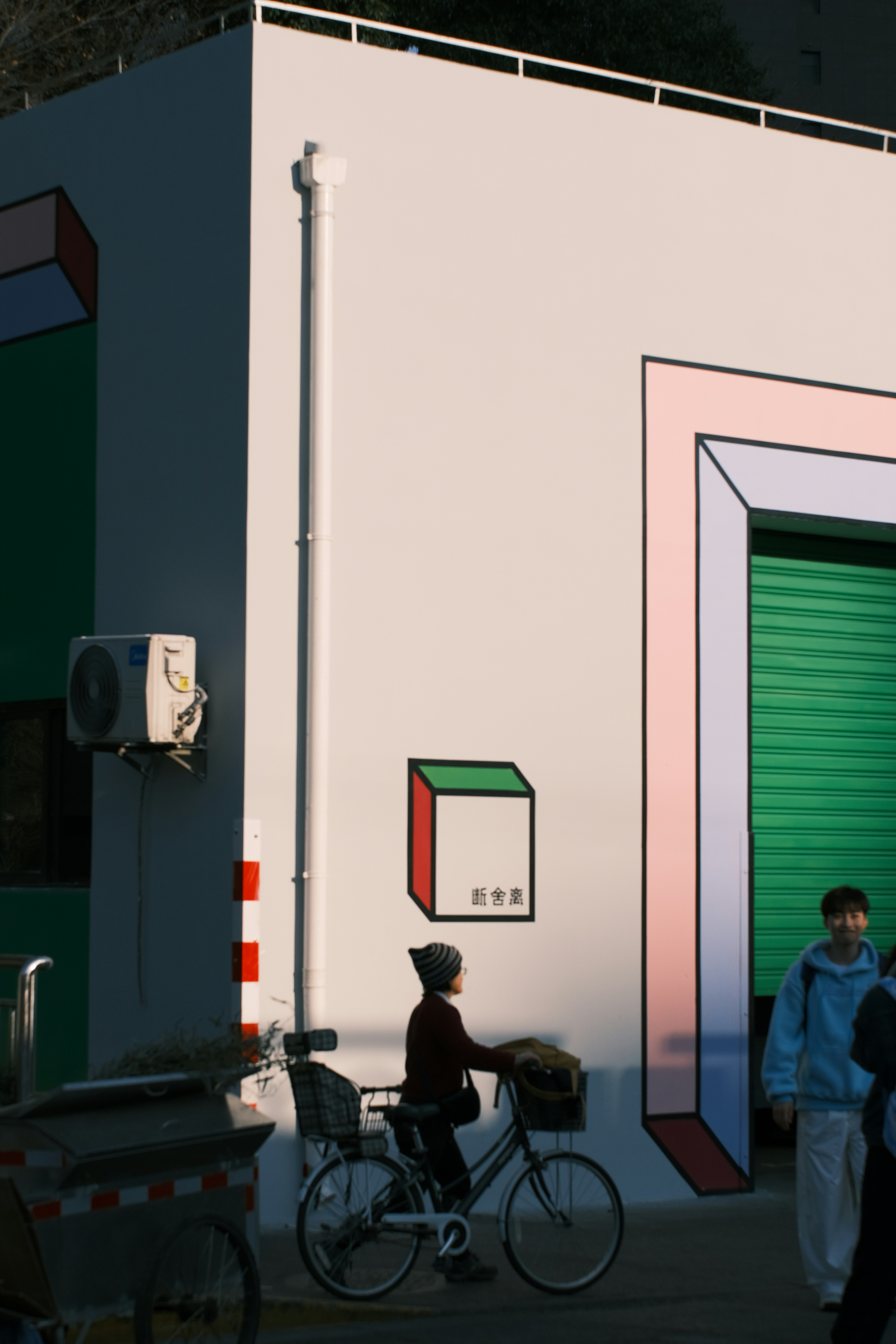 Wall Gallery at Dusk: A Quiet Street Scene with a Cyclist