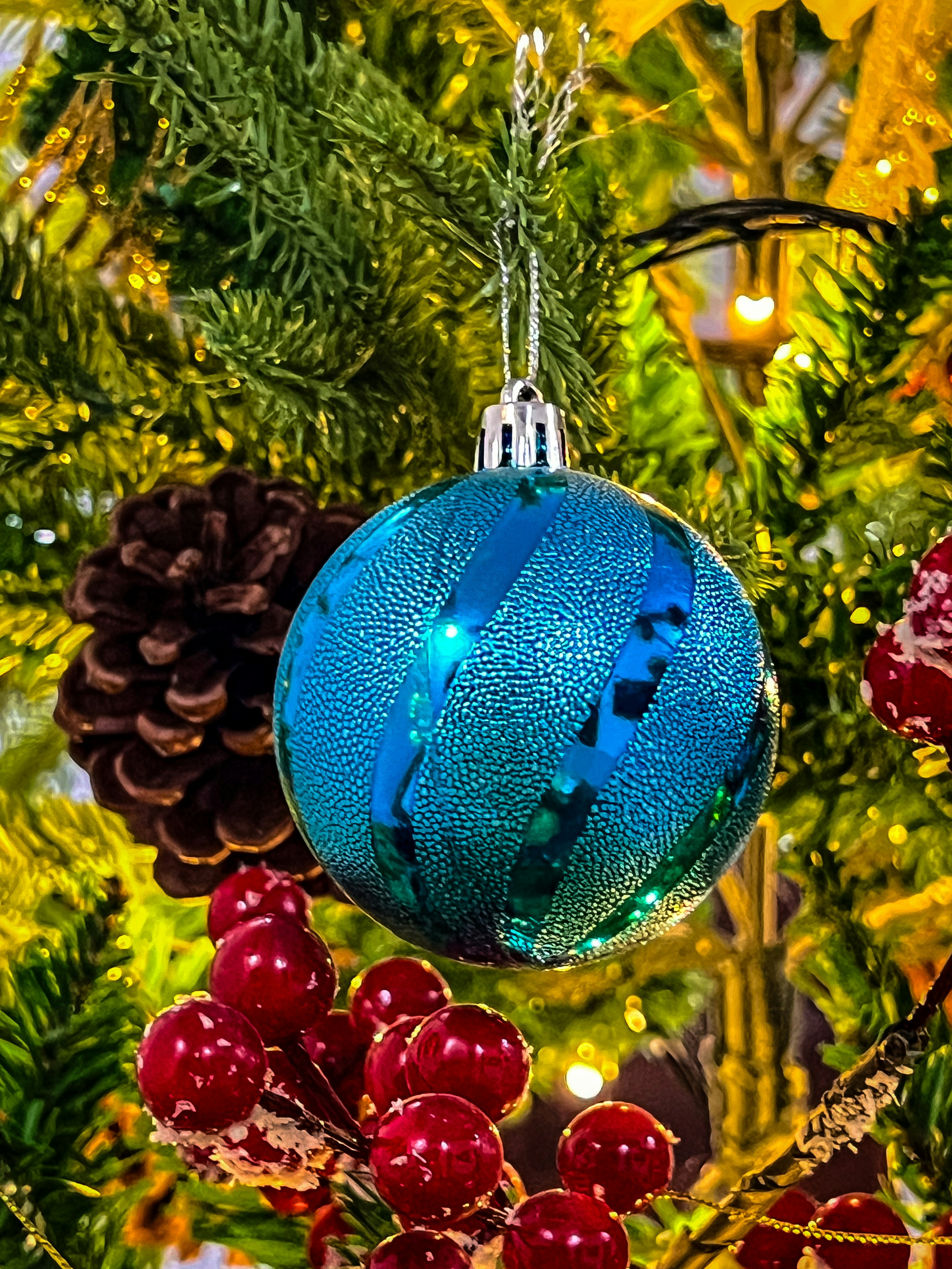 Blue ornament centerpiece among festive greenery